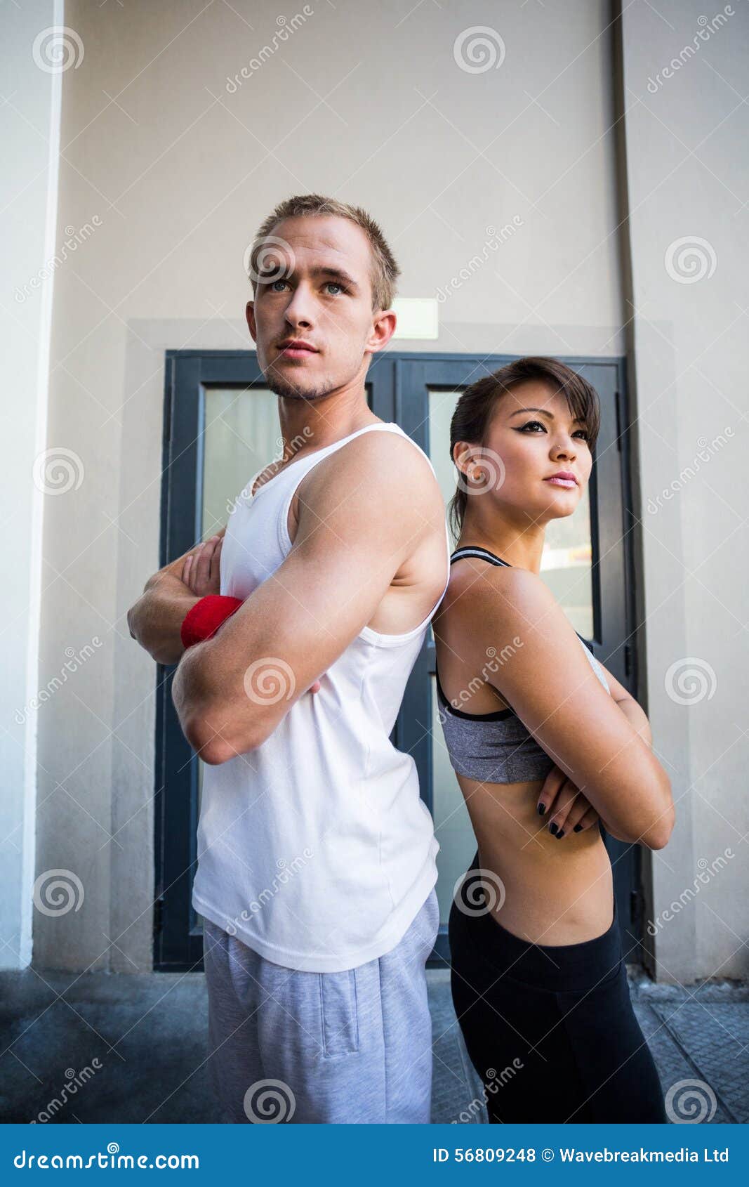 Extreme Athletes Standing Back To Back with Arms Crossed Stock Photo ...