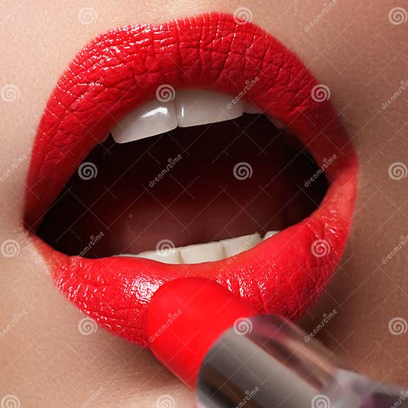 Extreme Close Up On Model Applying Red Lipstick Makeup Professional