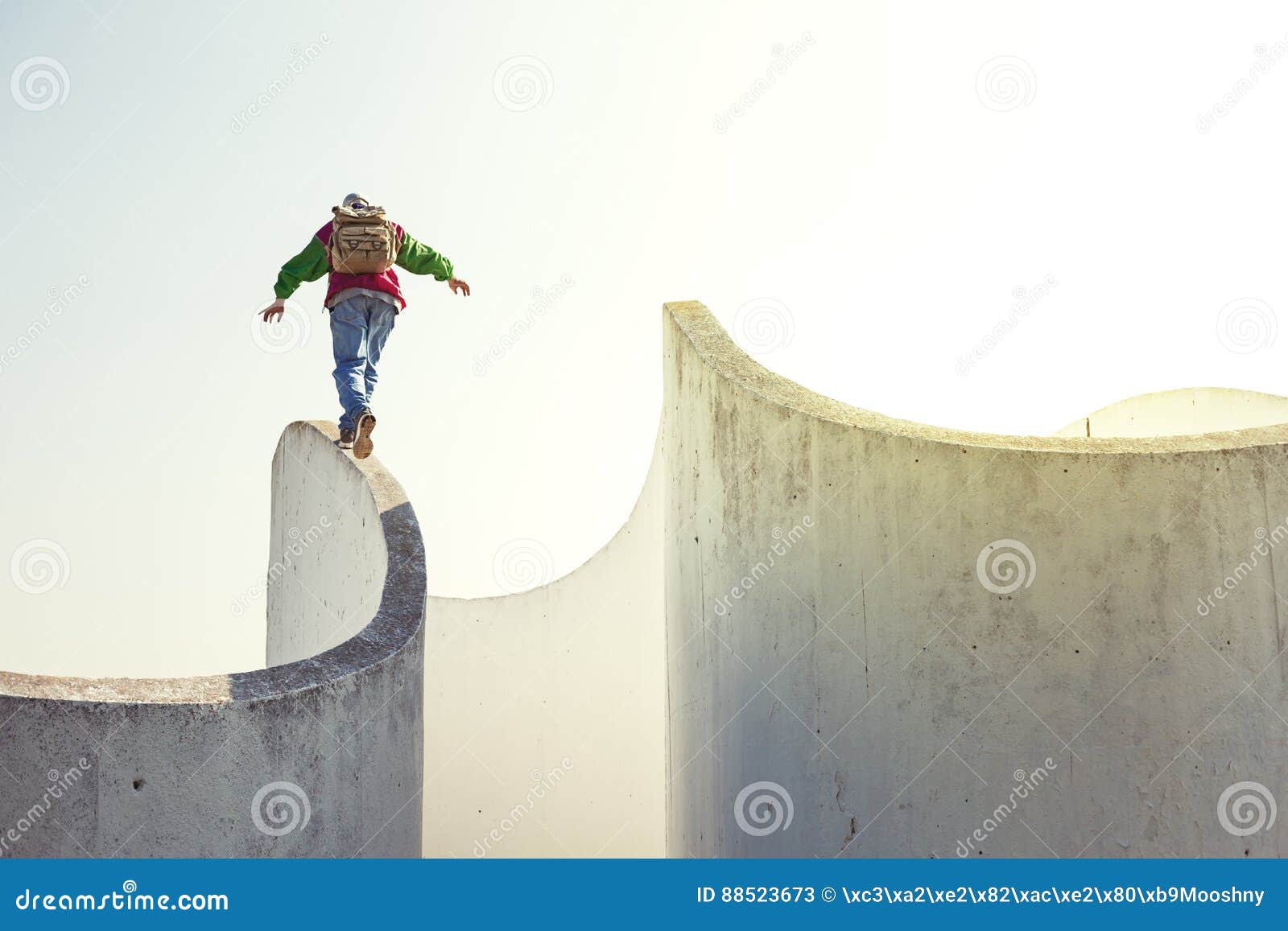 Extreme Man with Backpack Walking on a Thin Concrete Wall Stock Image ...