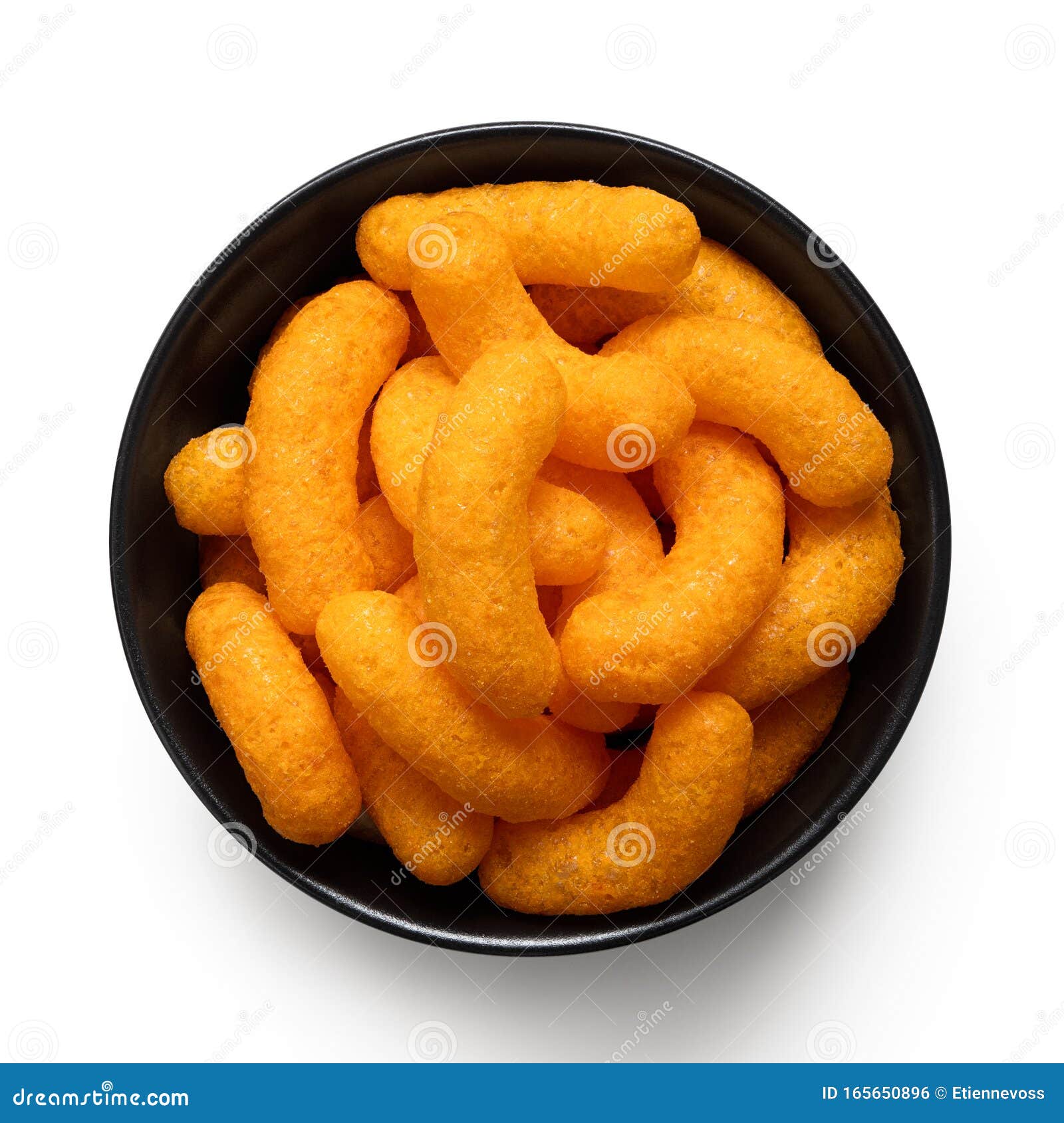Extruded Cheese Puffs In A White Ceramic Bowl Next To Spilled Cheese ...