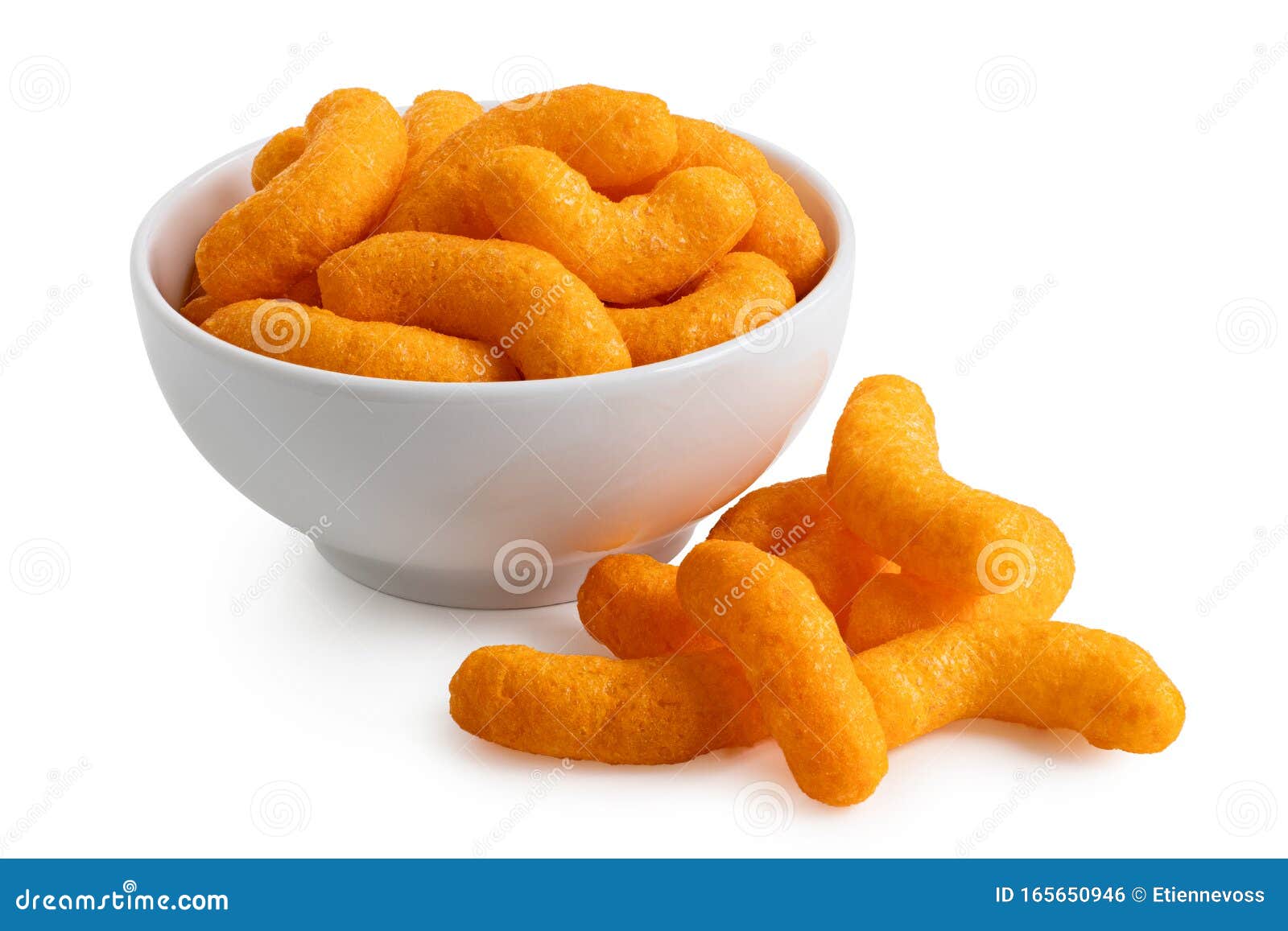 Extruded Cheese Puffs In A White Ceramic Bowl Next To Spilled Cheese ...