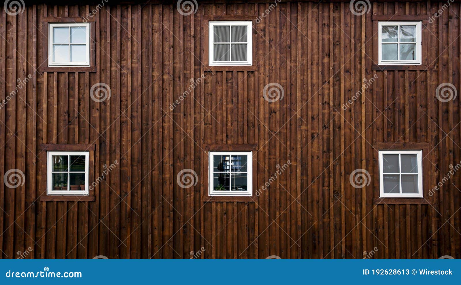 Eye-level Shot of the Facade of a Wooden Building with Windows Stock ...
