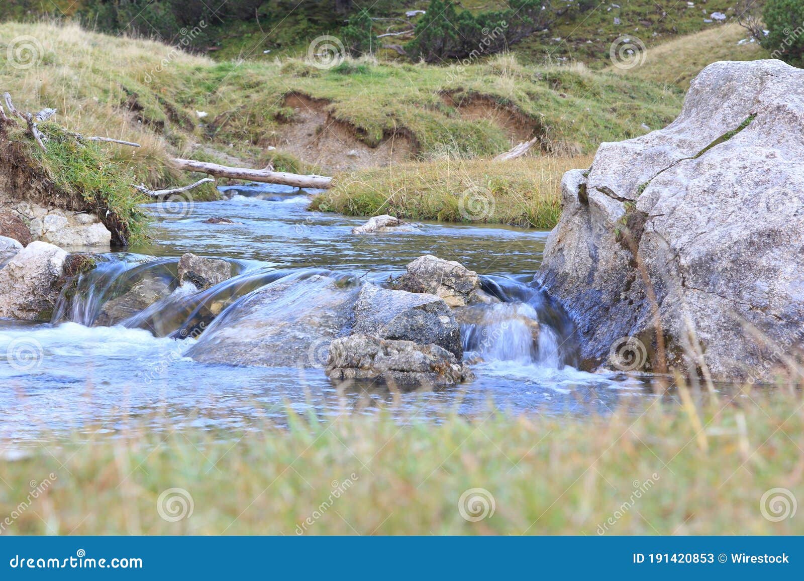 Eye-level Shot of a Small Waterfall of a River in a Field Stock Image ...