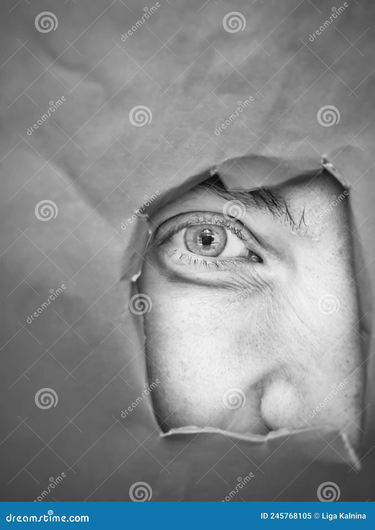 Eye through paper hole stock image. Image of tear, face - 245768105