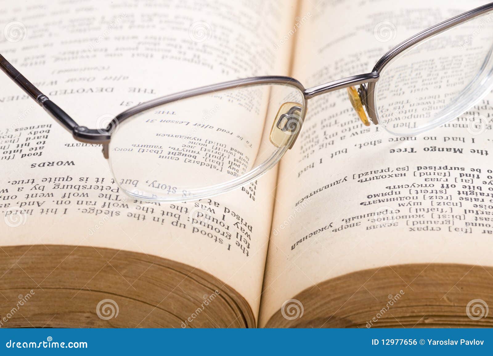 Eyeglasses on a book stock photo. Image of wisdom, page - 12977656
