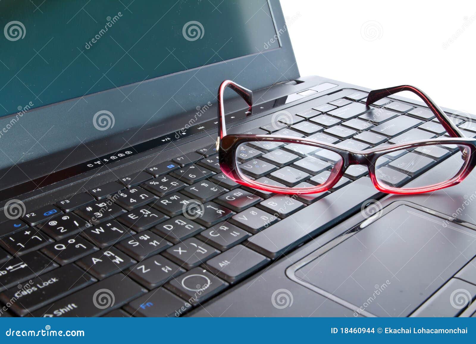 Eyeglasses on the laptop stock photo. Image of computer - 18460944