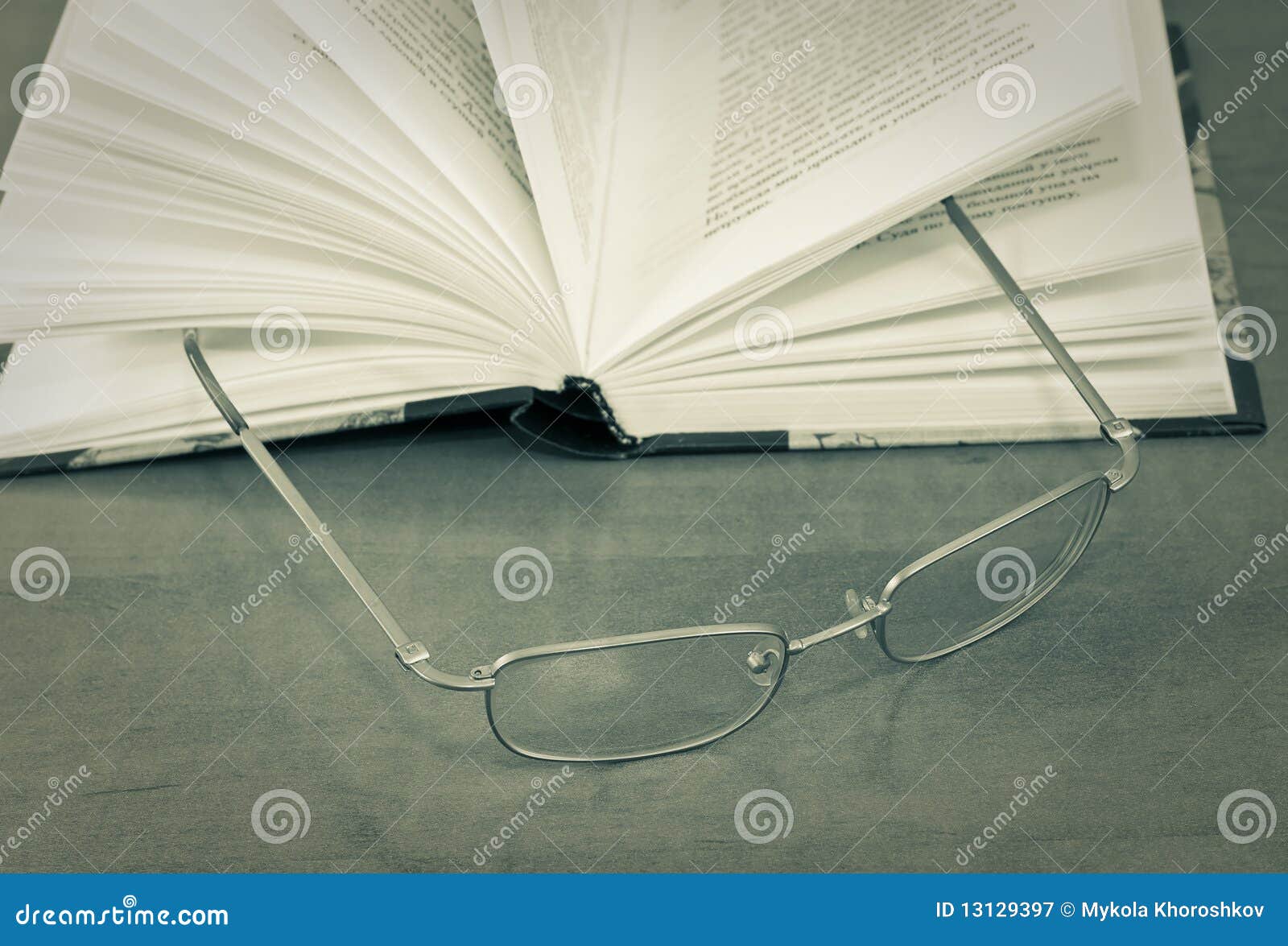 Eyeglasses on open book stock image. Image of reading - 13129397