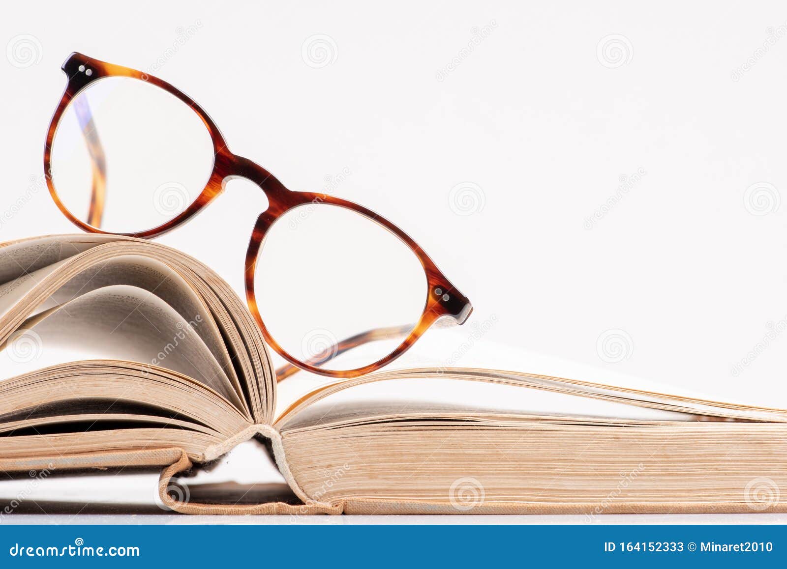 Eyeglasses on open book stock image. Image of knowledge - 164152333