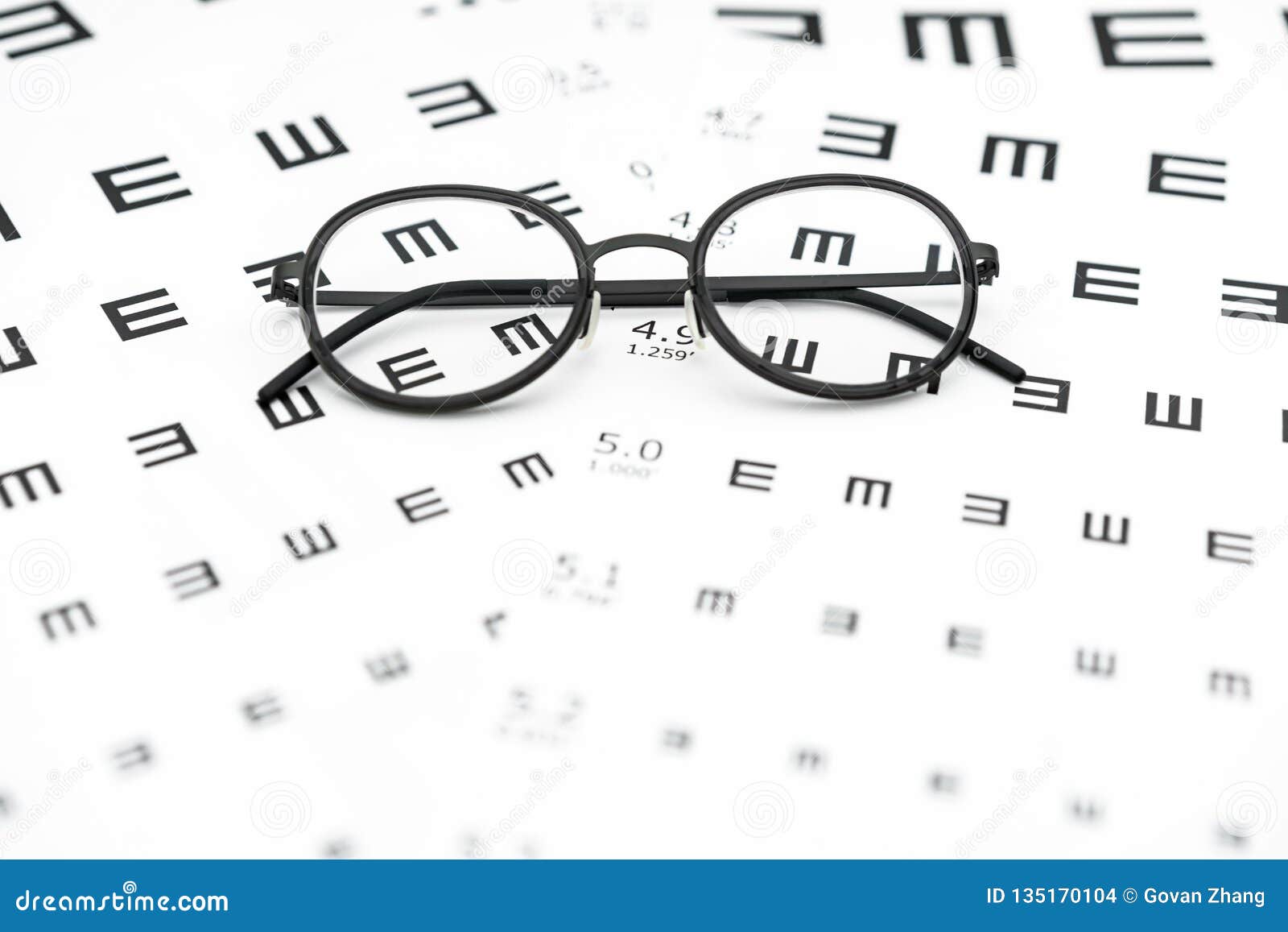 Eyeglasses and Visual Acuity Chart in White Background Stock Photo ...