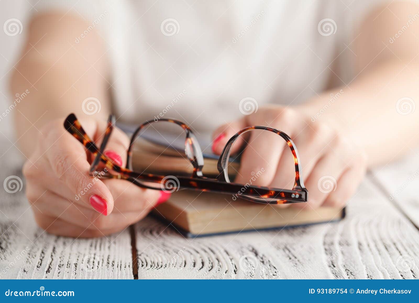 Eyeglasses with Woman Reading Book in Room, Selective Focus Stock Photo ...