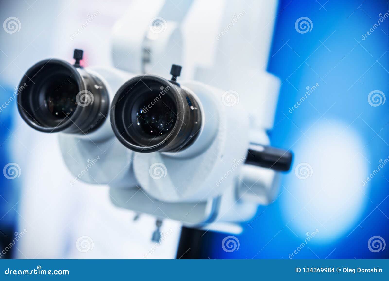 The Eyepieces of the Microscope are Taken Large on a Blue Background ...