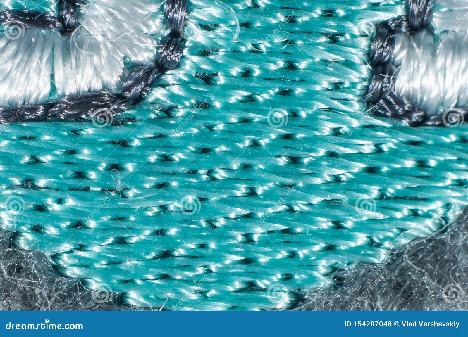 Fabric with an Insert of Thin Bright Turquoise Threads Close-up Macro ...