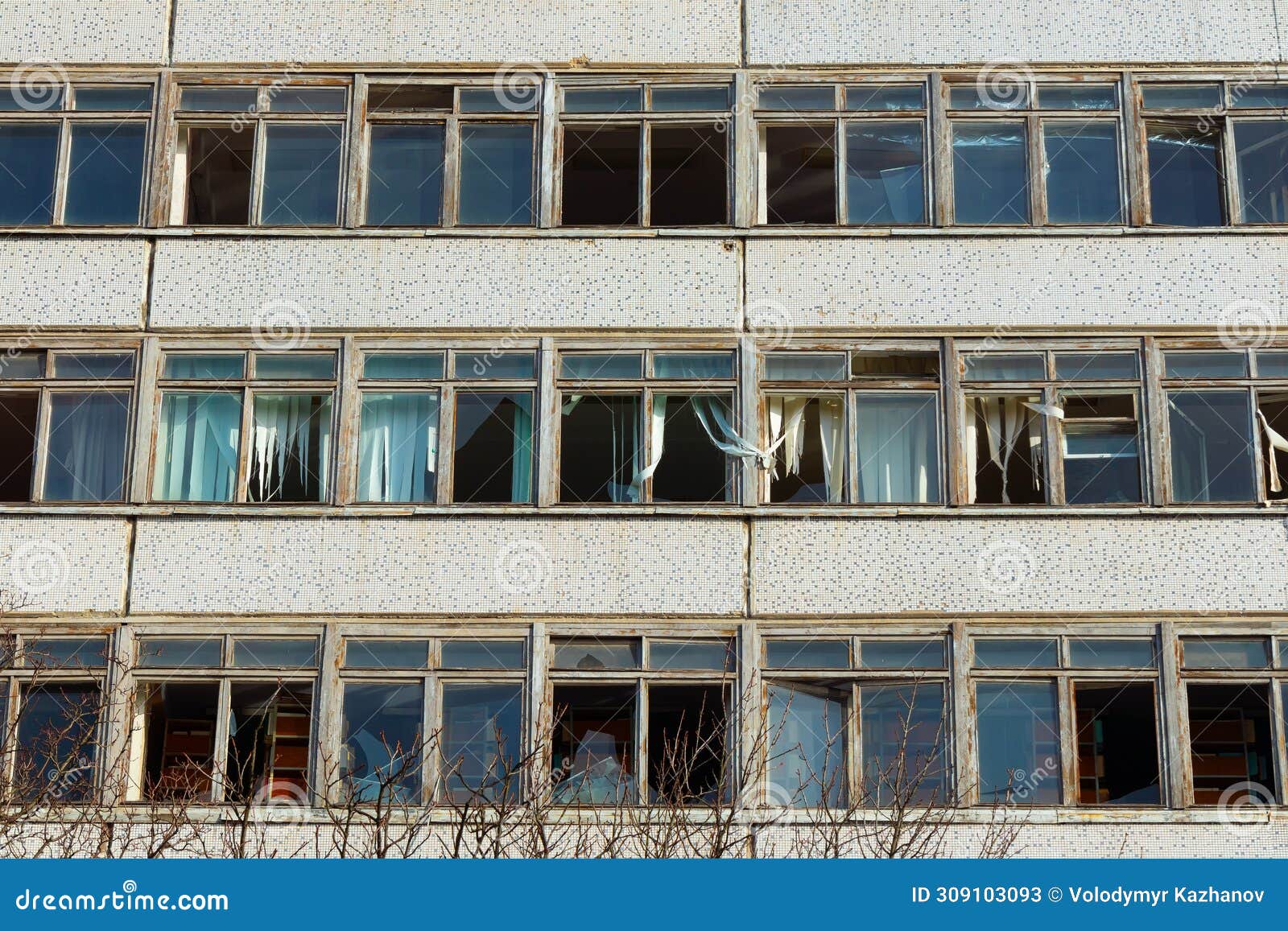 Facade of an Abandoned Multi-story Building with Broken Glass in the ...