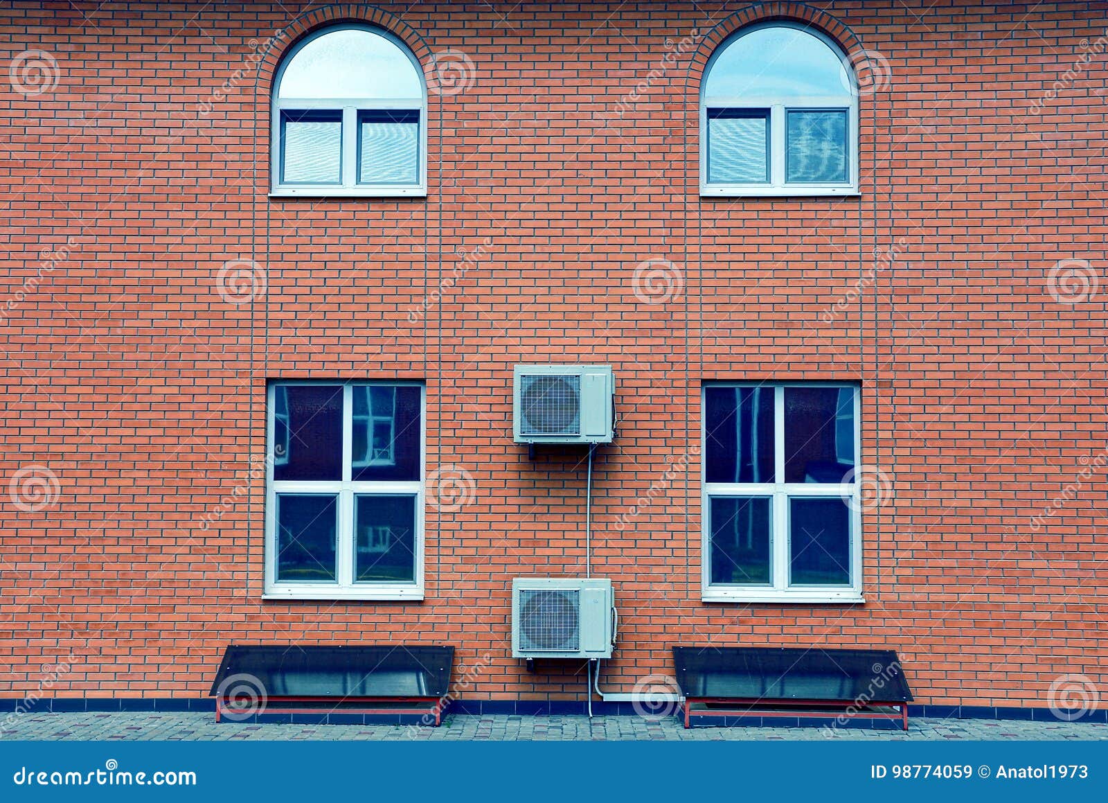 The Facade of a Brick Building with Windows and Air Conditioning Stock ...