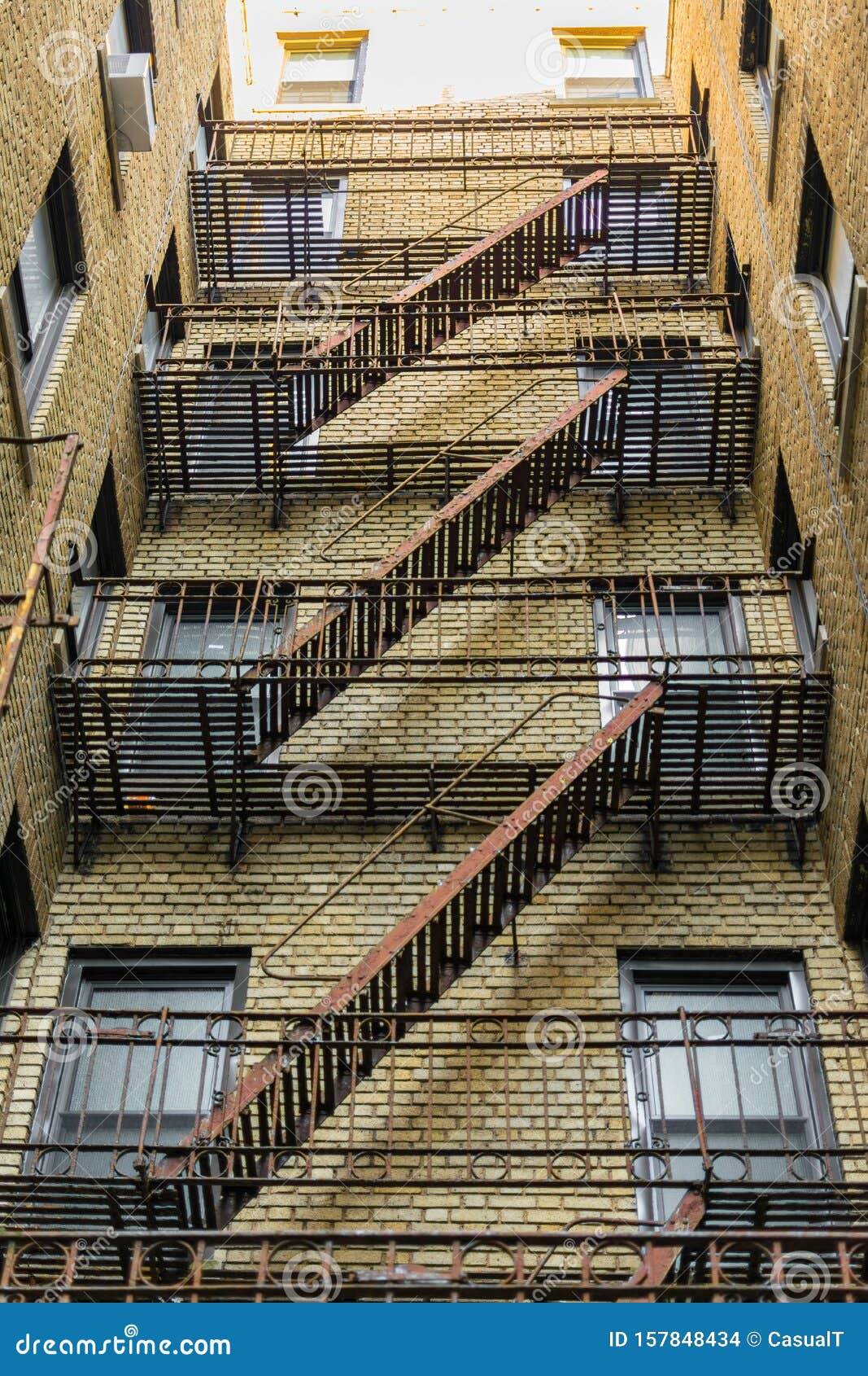 Facade of a Brownstone with Old Rusty Fire Escape Stock Photo - Image ...