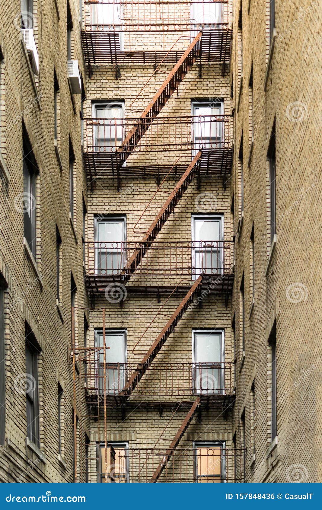 Facade of a Brownstone with Old Rusty Fire Escape Stock Photo - Image ...