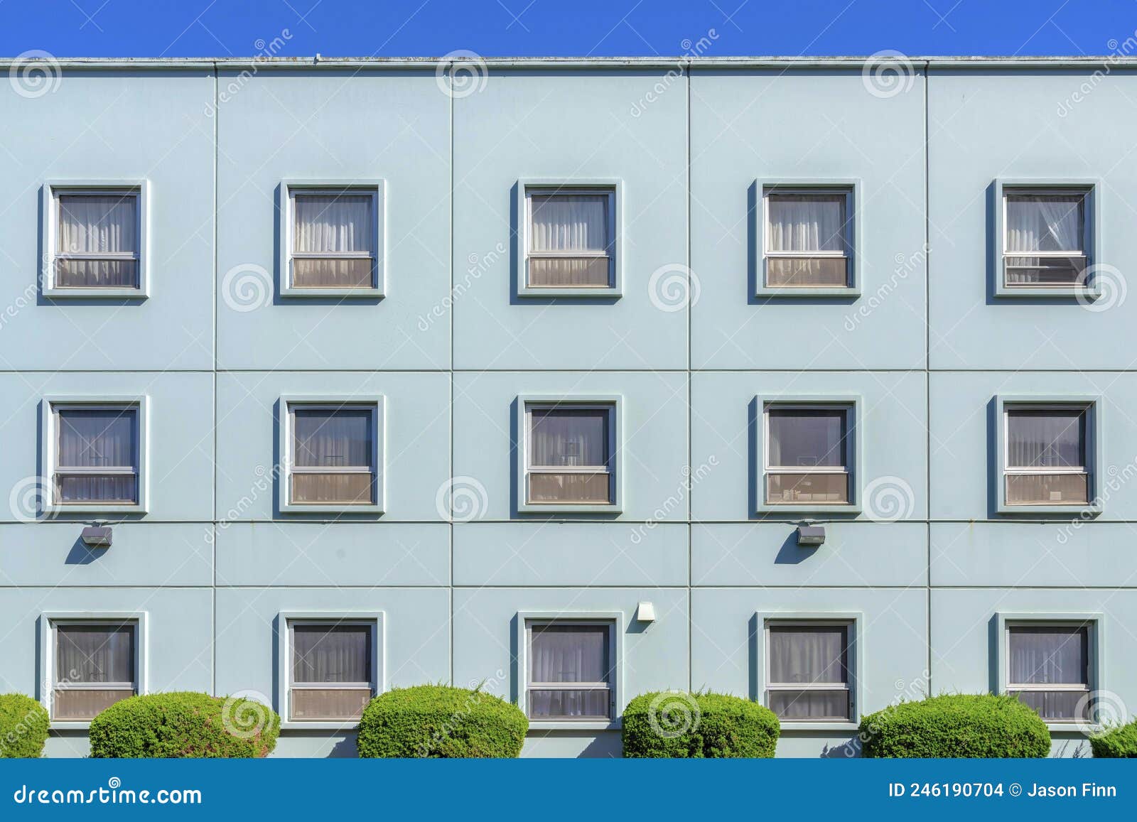 Facade of a Building with Light Blue Interior and Square Single Hung ...