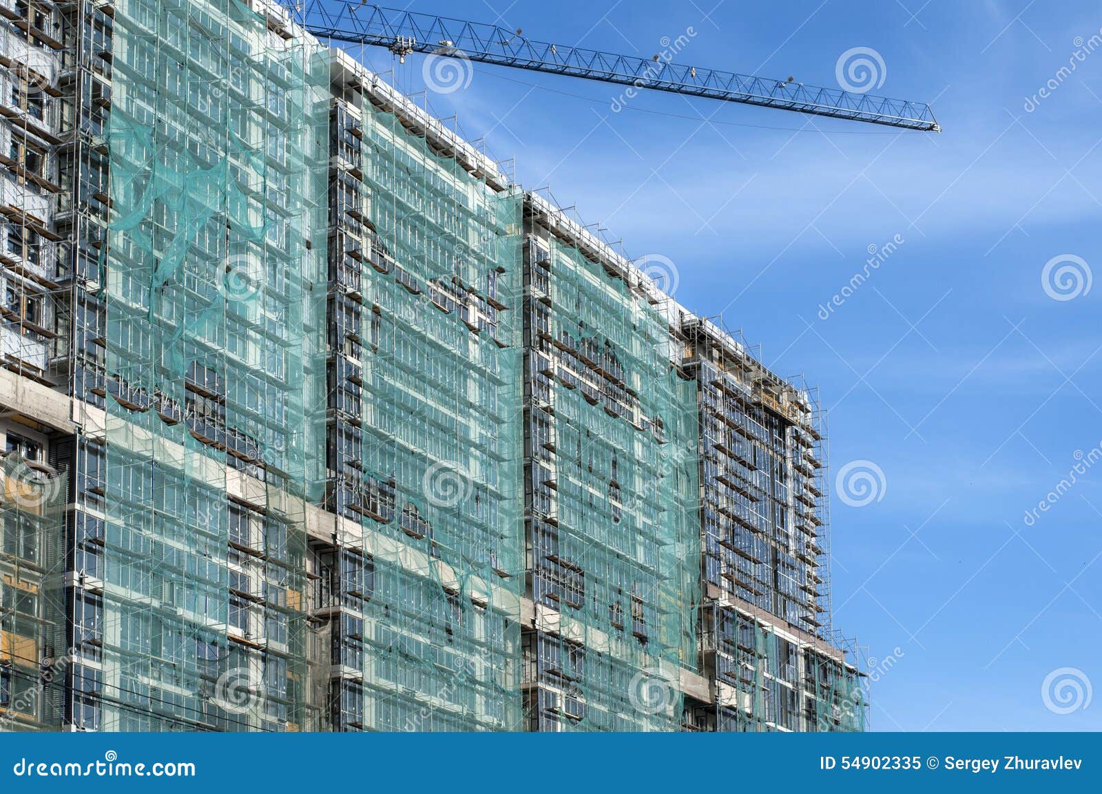 Facade of a Building Under Construction with a Protective Mesh Stock ...
