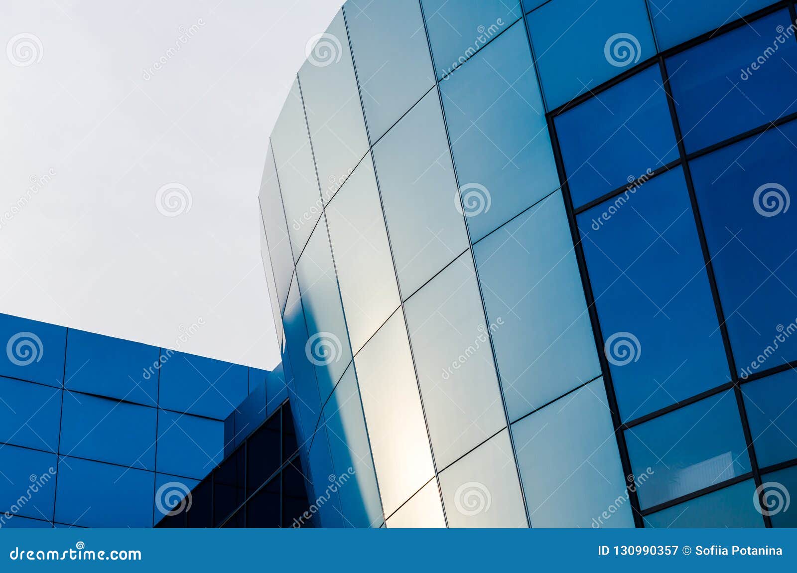 Facade of an Office Building with Blue Walls and Mirrored Window Stock ...