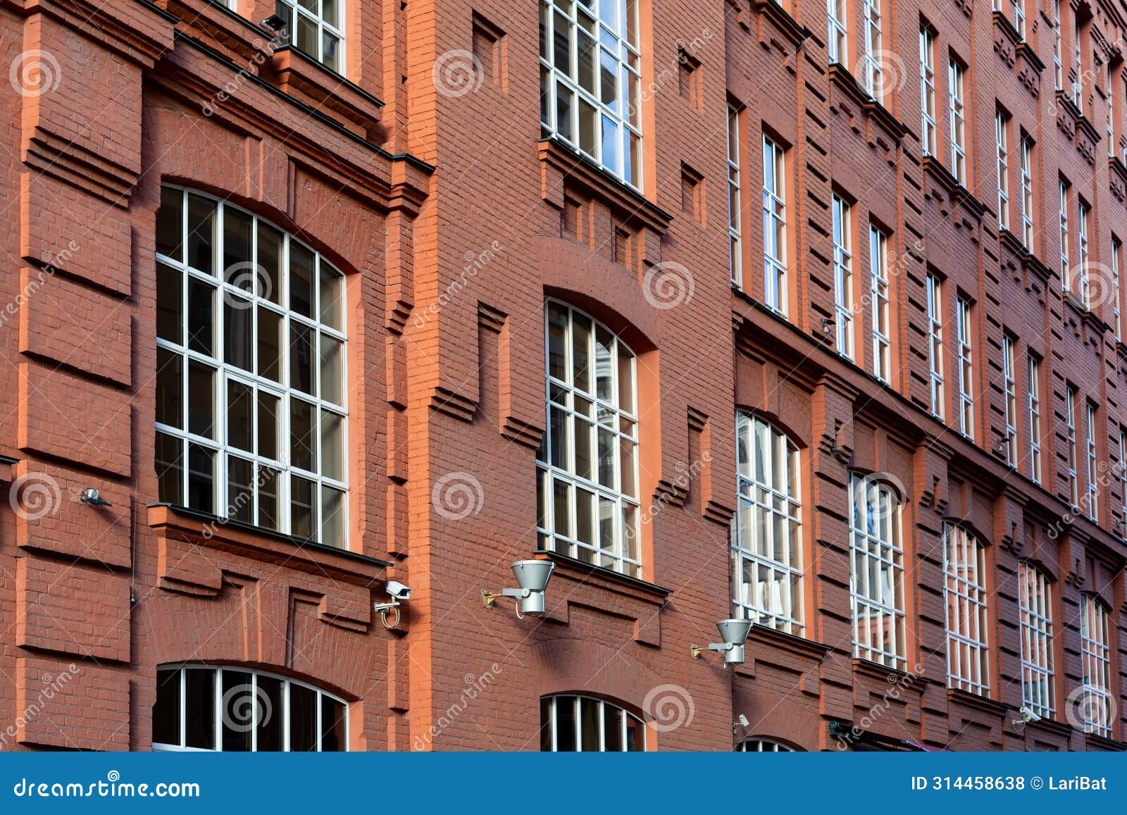 Facade of Old Classic Red Brick Building with Large Windows with White ...