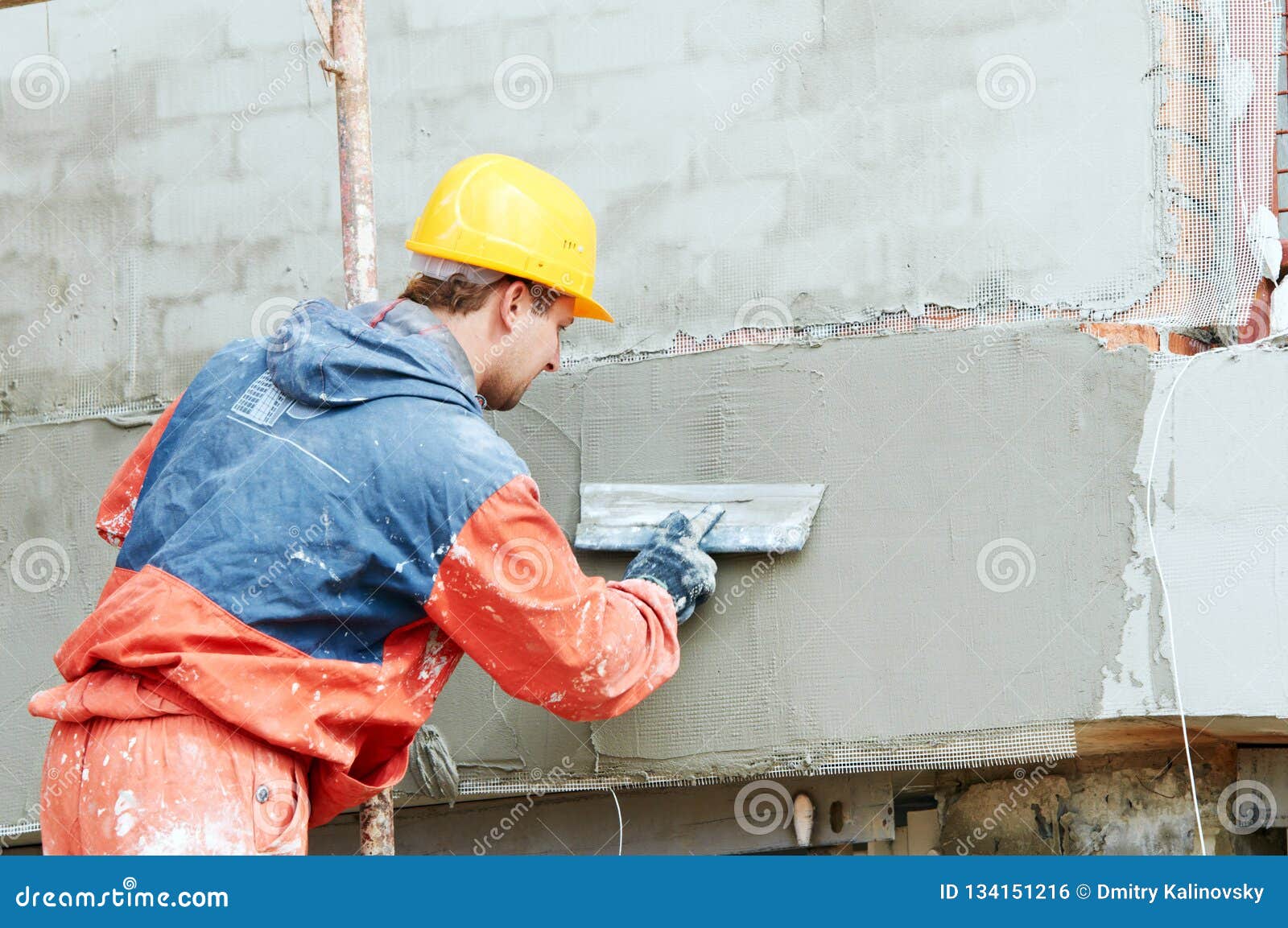 Facade Work. Builder Plastering Outside Wall with Putty Knife Float ...
