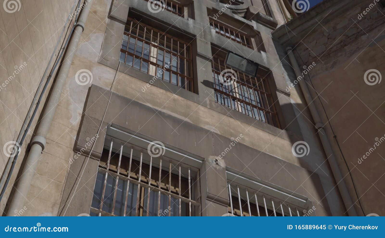Facade of the Prison Building with Spotlight on Wall and Bars on ...