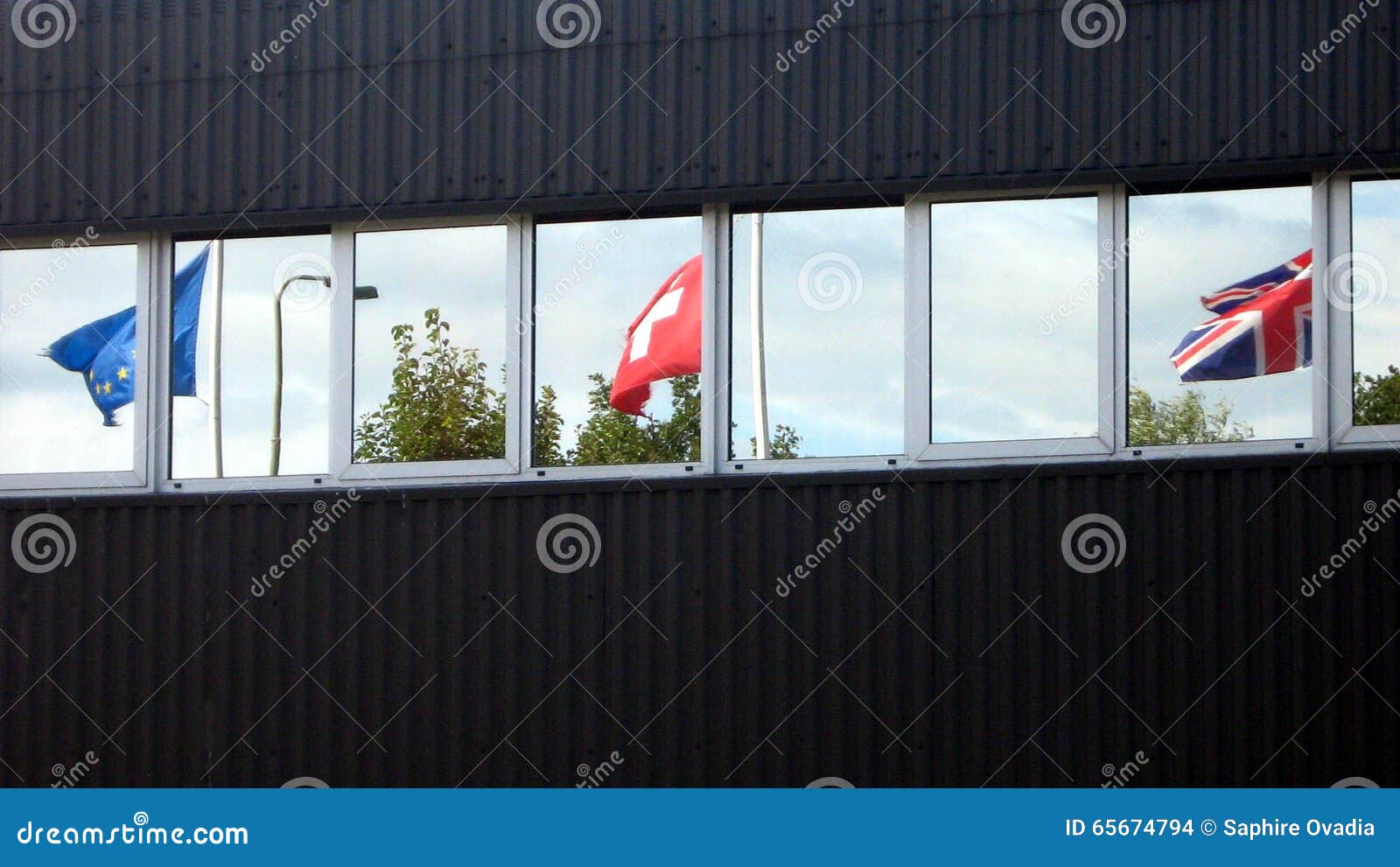 Facade with Reflection of Flags Stock Photo - Image of jack, european ...