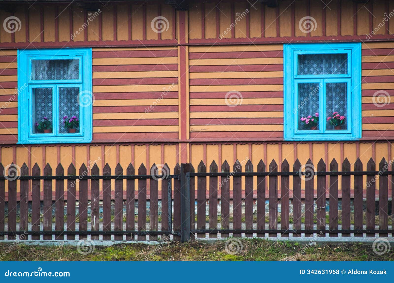 The Facade of a Traditional Wooden Cottage with Two Windows with Blue ...