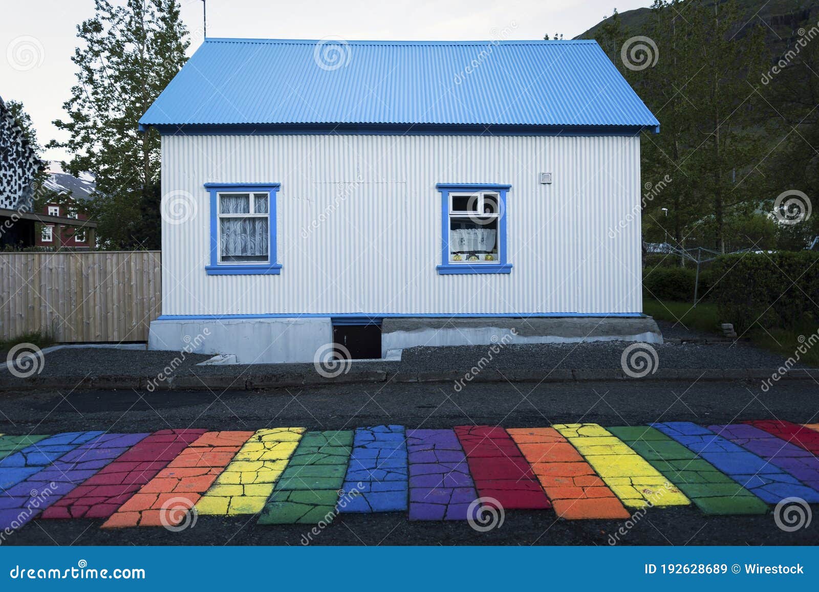 Facade of a White and Blue House by the Colorful Pavements in Front of ...