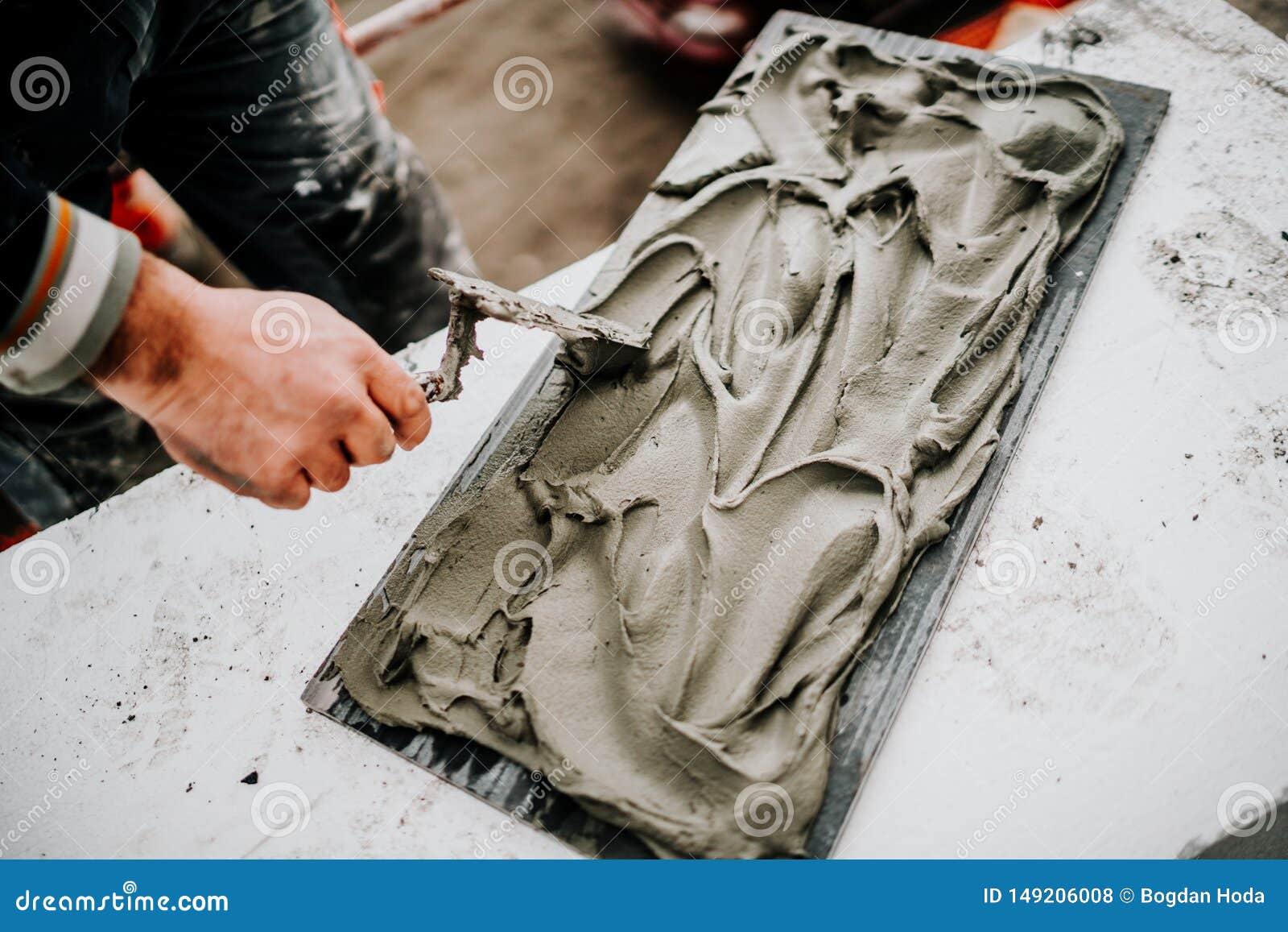 Facade Builder Working on Stone Tiles. Details of Worker Using Mortar ...