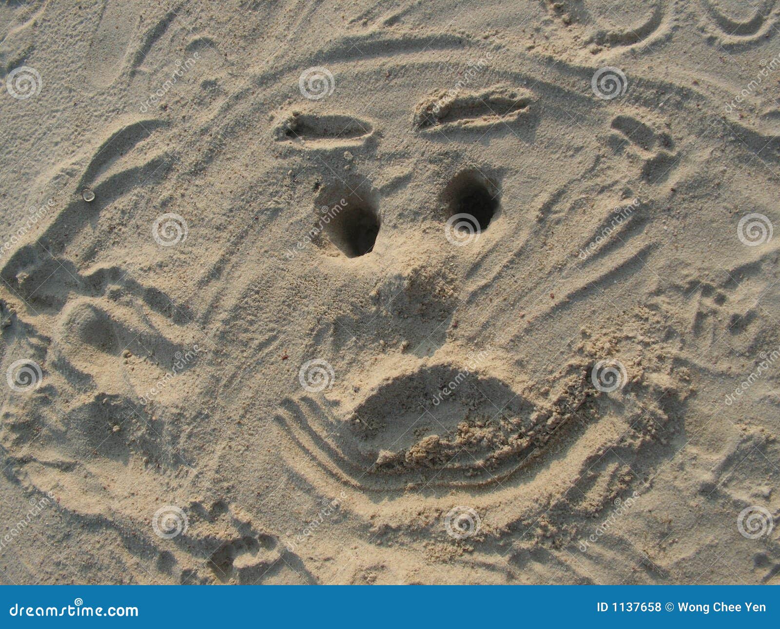 Face drawn in sand stock photo. Image of beach, sand, face - 1137658