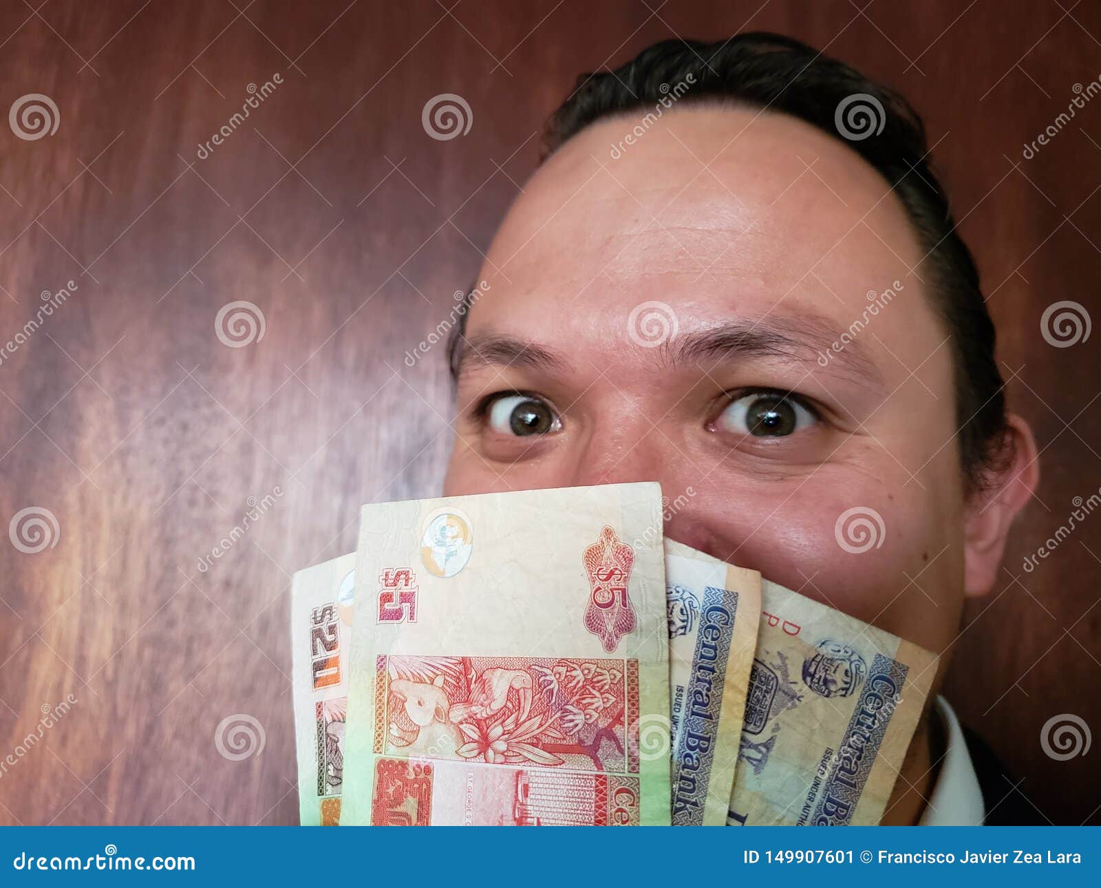 Face with Emotion Expression of a Young Man and Belizean Banknotes ...