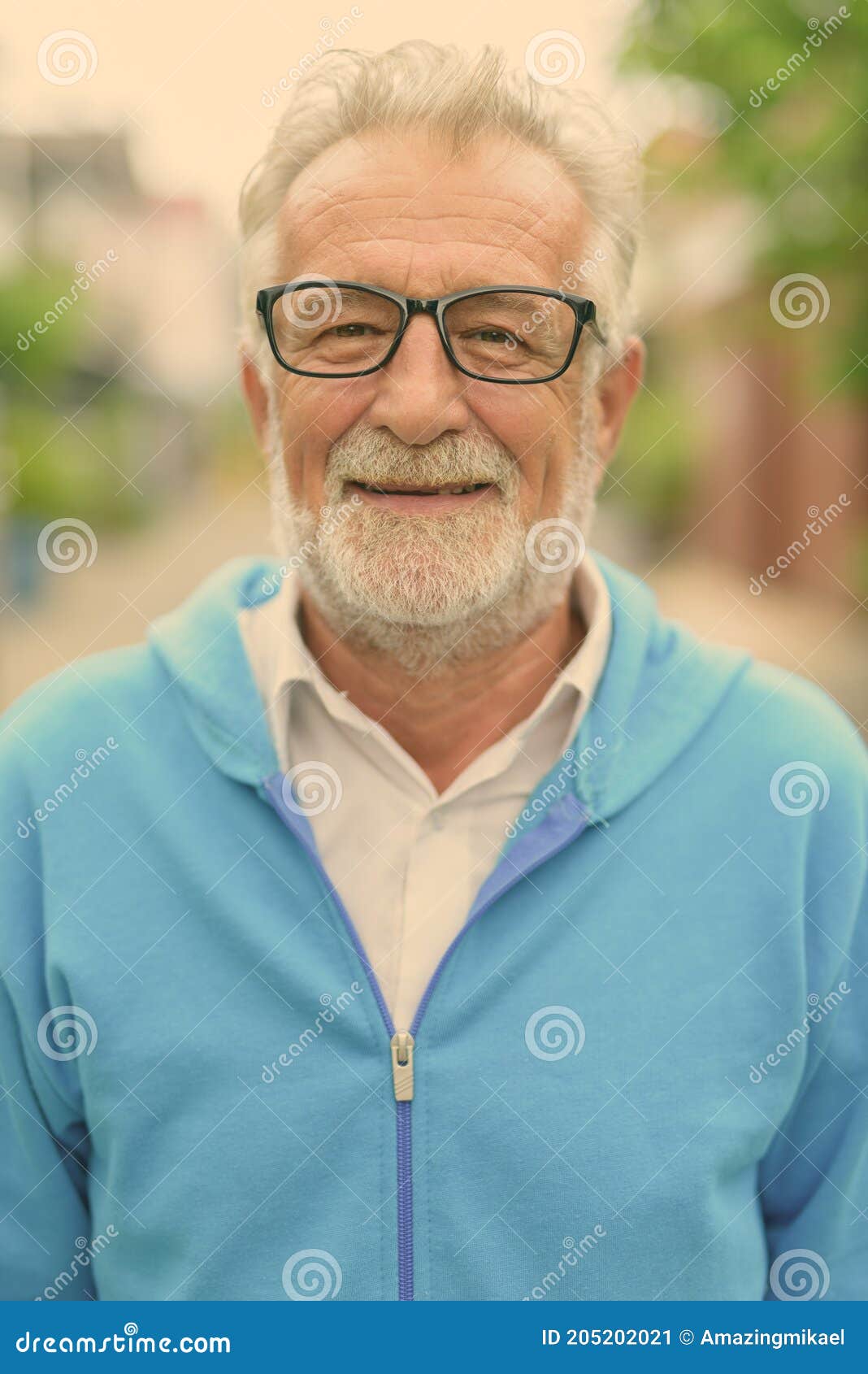 Face Of Happy Handsome Senior Bearded Man Smiling While Wearing Blue