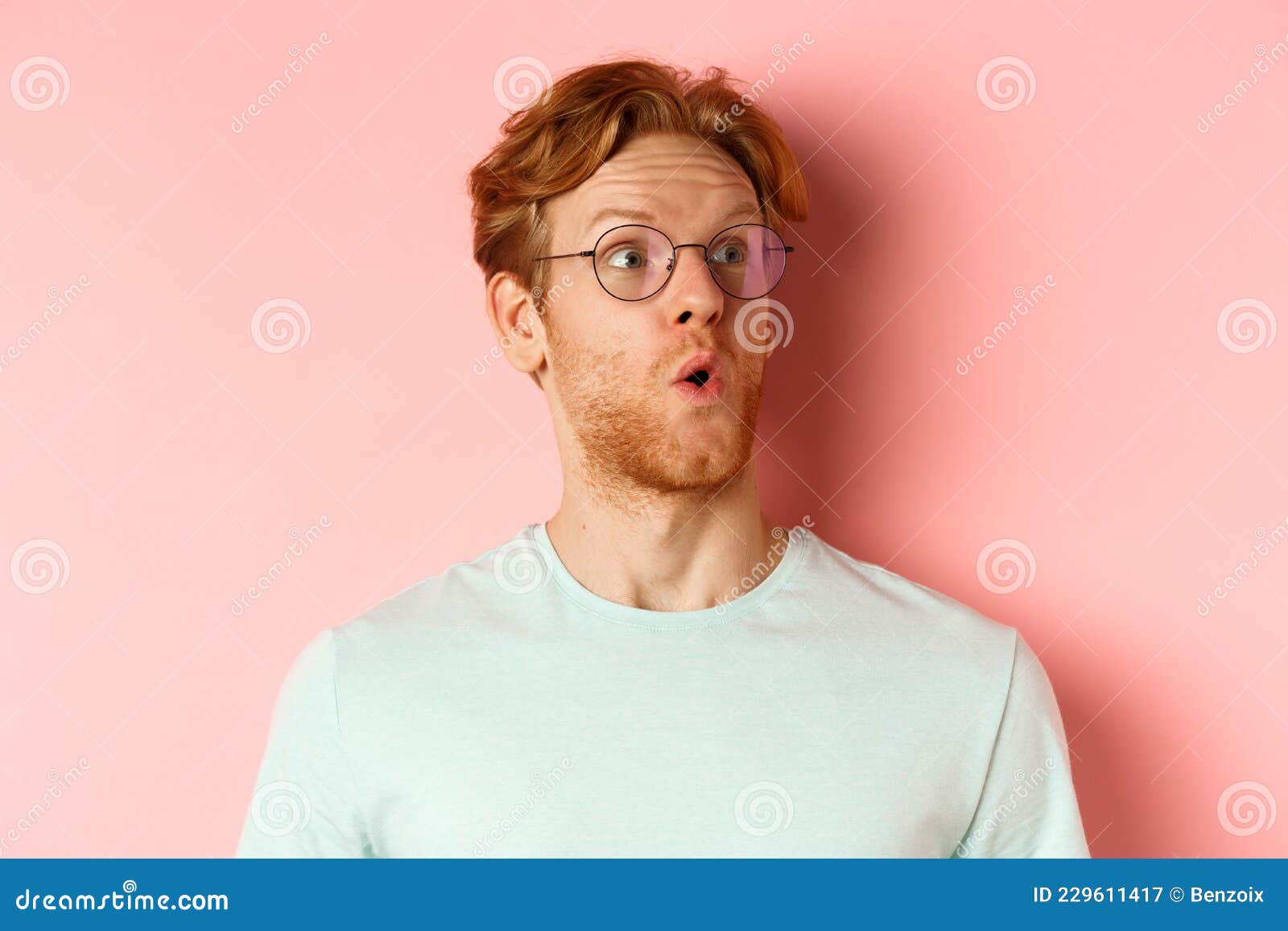 Face Of Intrigued Young Man With Ginger Hair And Beard Raising
