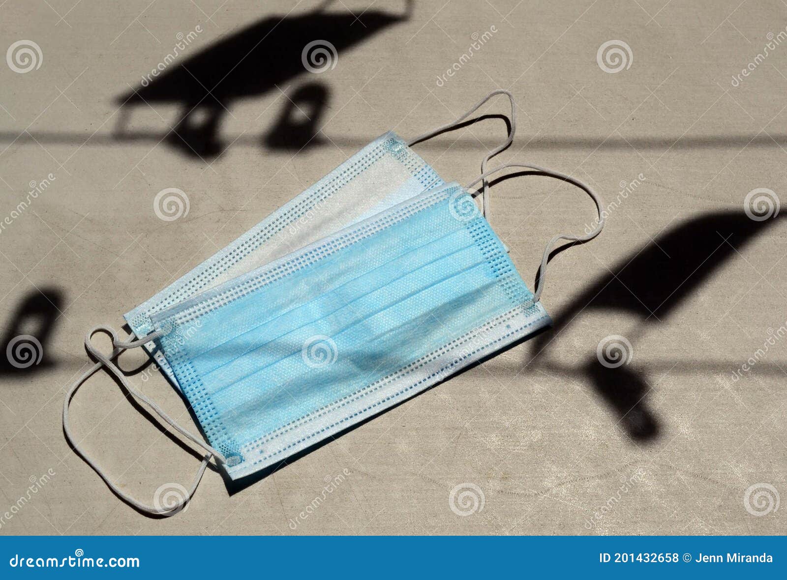 Face Mask on the Table with Shadow Under the Sunlight Stock Photo ...