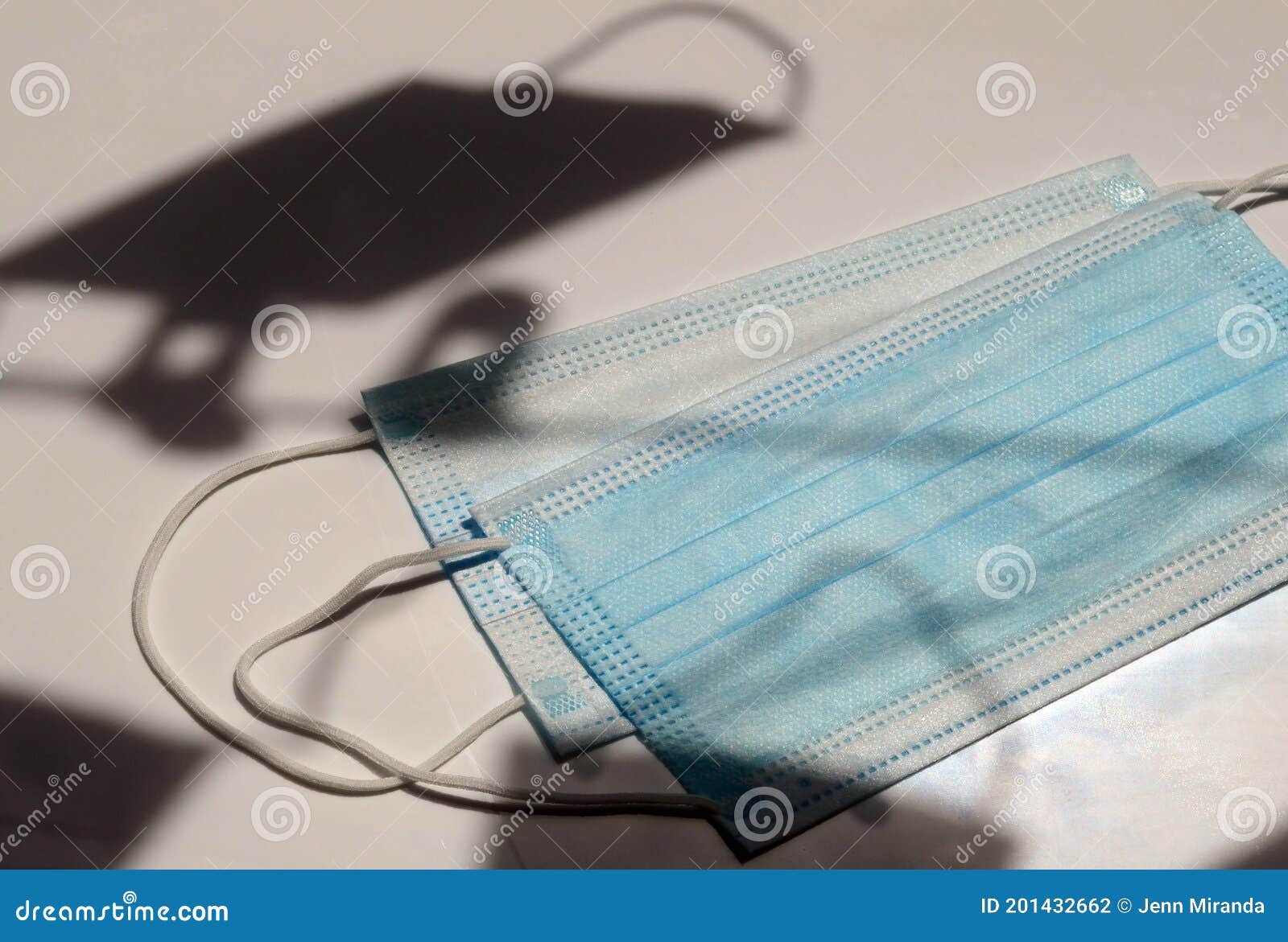 Face Mask on the Table with Shadow Under the Sunlight Stock Photo ...