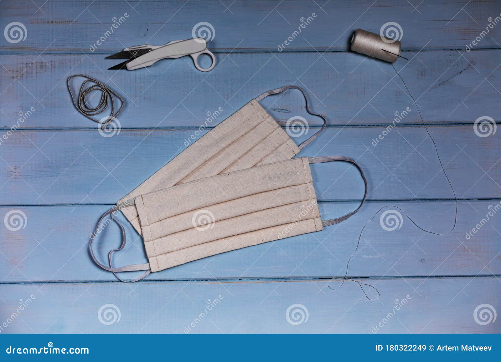Face Mask, Thread with Needle on a Blue Background. Stock Image - Image ...