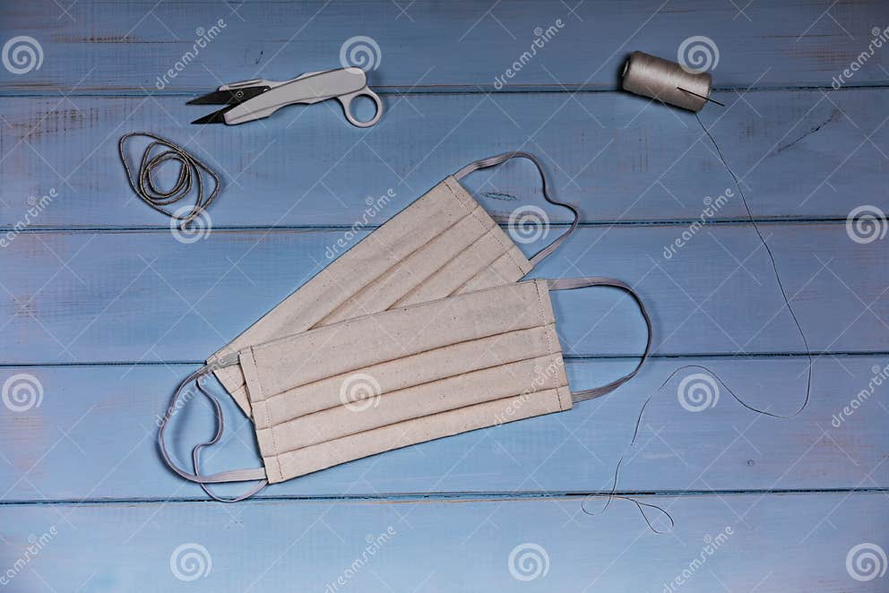 Face Mask, Thread with Needle on a Blue Background. Stock Image - Image ...