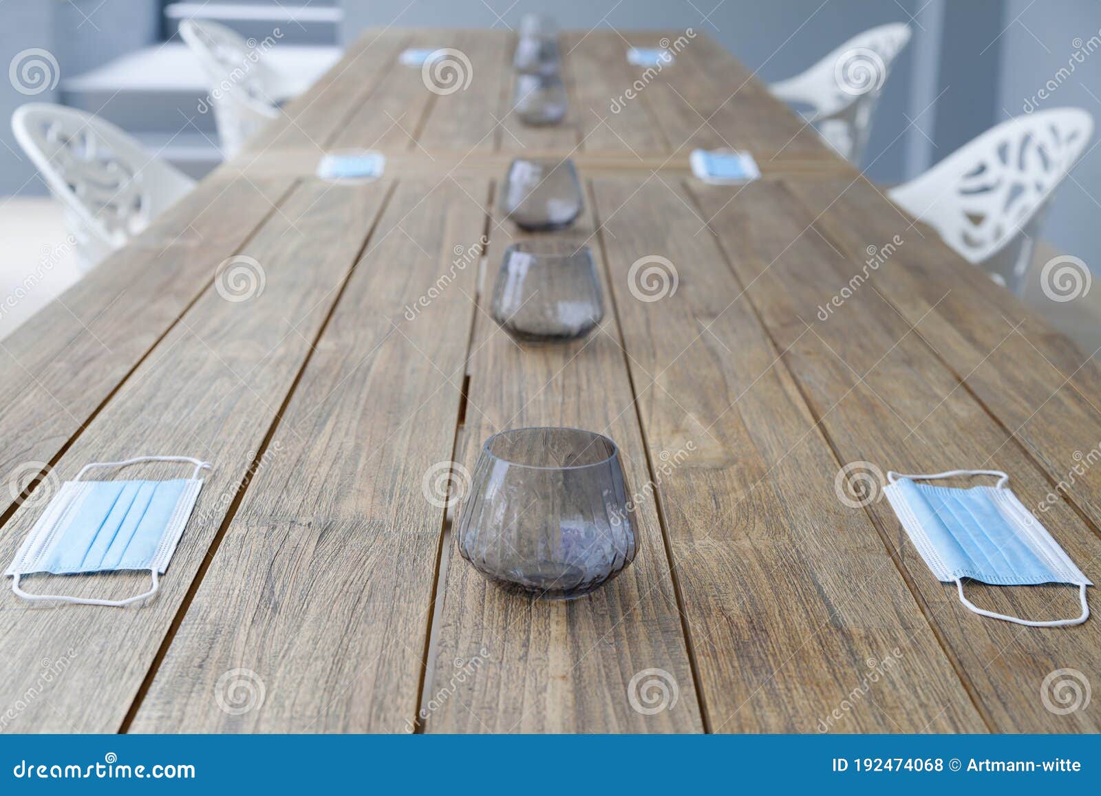Face Masks Lying on a Table with Gaps between the Chairs for Social ...