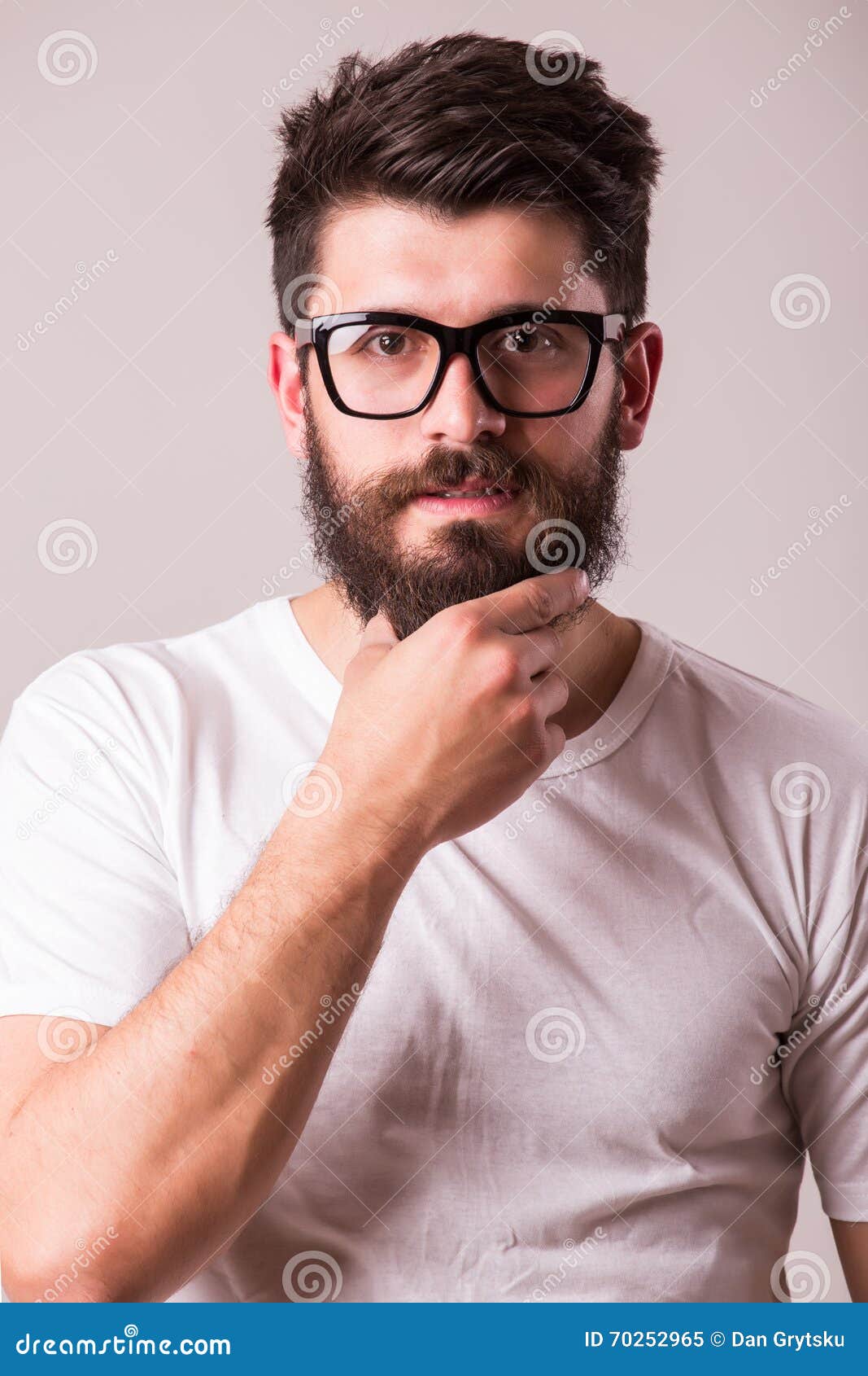 Face Portrait Of Bearded Man In Glasses With Hand On Beard Stock Image