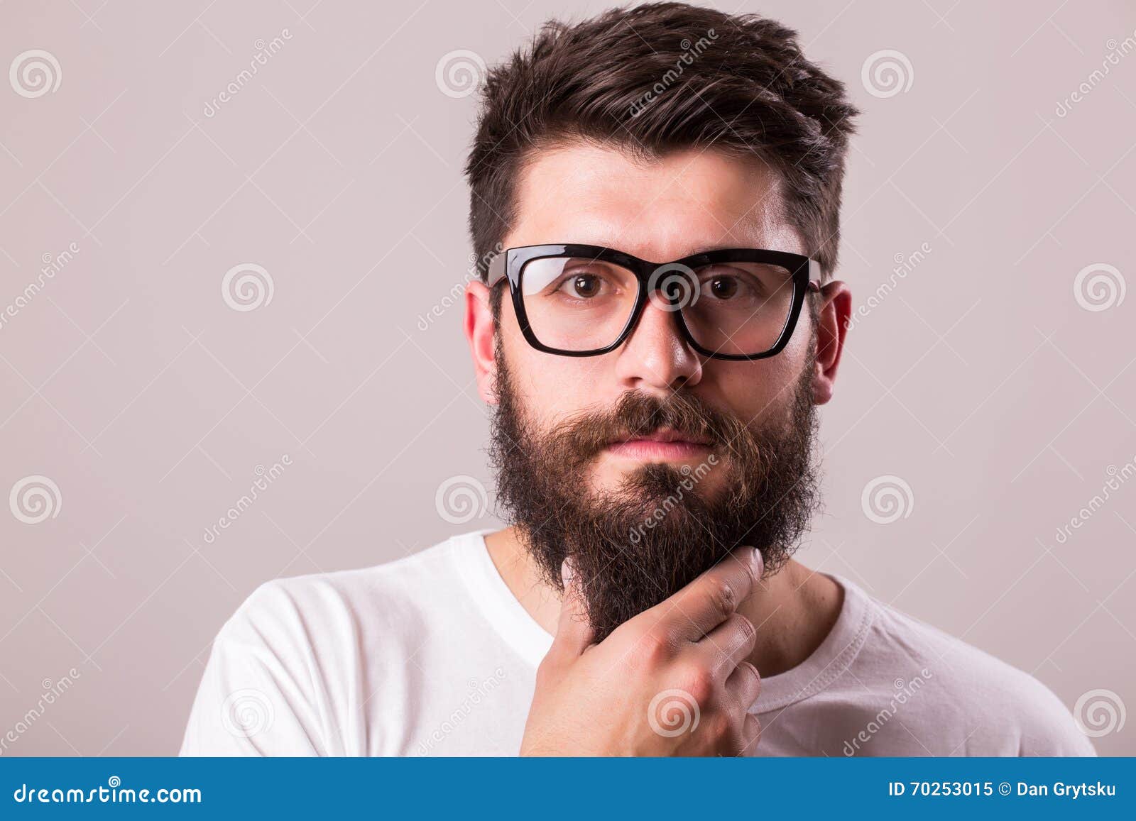 Face Portrait Of Bearded Man In Glasses With Hand On Beard Stock Image