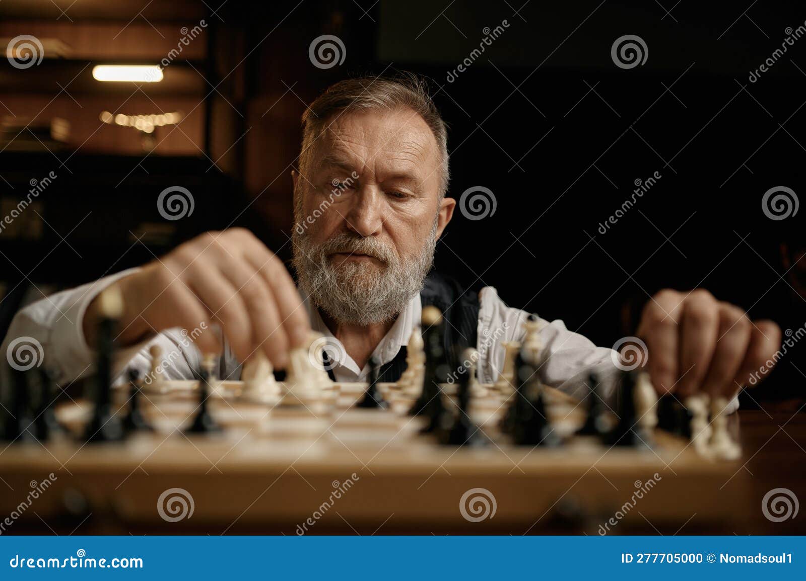 Face Portrait of Senior Man Moving Chess Piece on Board during ...