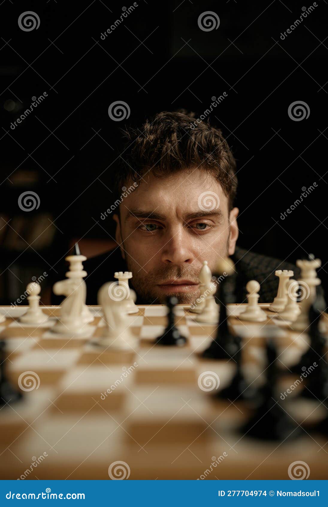 Face Portrait of Young Man Player Considering Chess Piece Position on ...