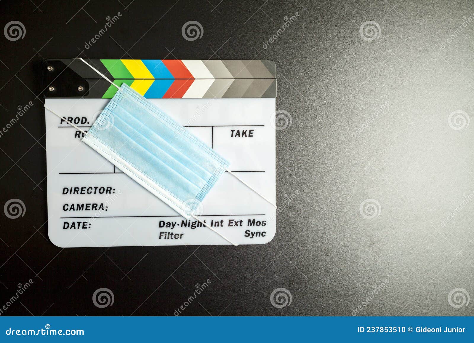 Face Protection Mask with Clapper Board on the Table on Black ...
