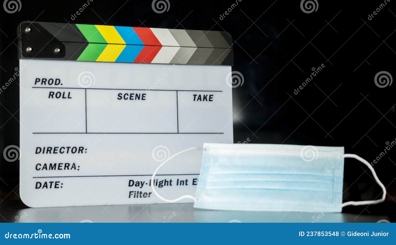 Face Protection Mask with Clapper Board on the Table on Black ...