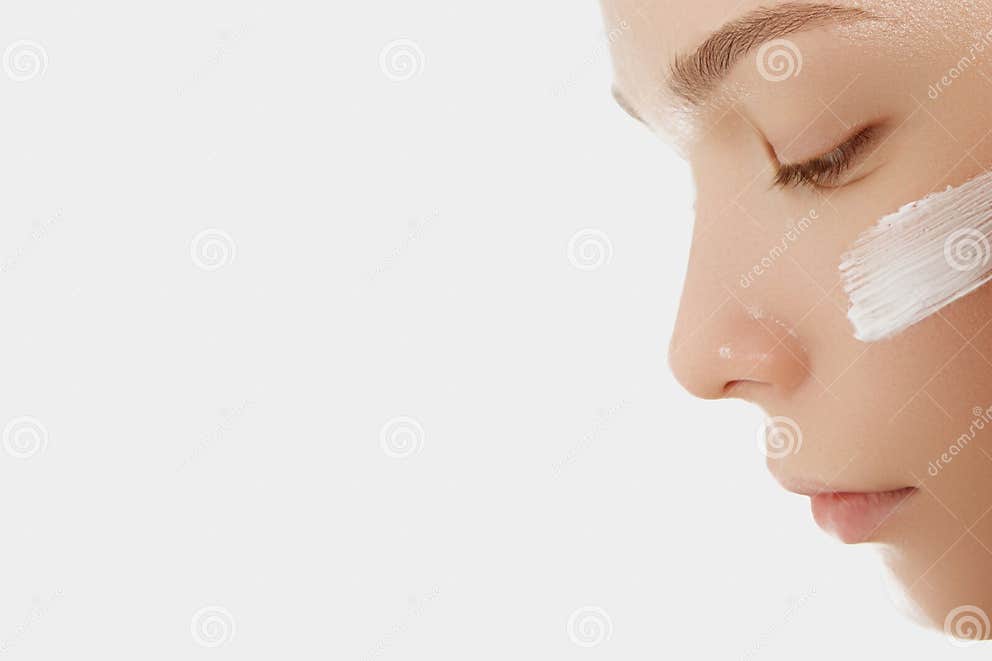 Face Skin Care Woman Applying Cosmetic Cream On Clean Hydrated Skin