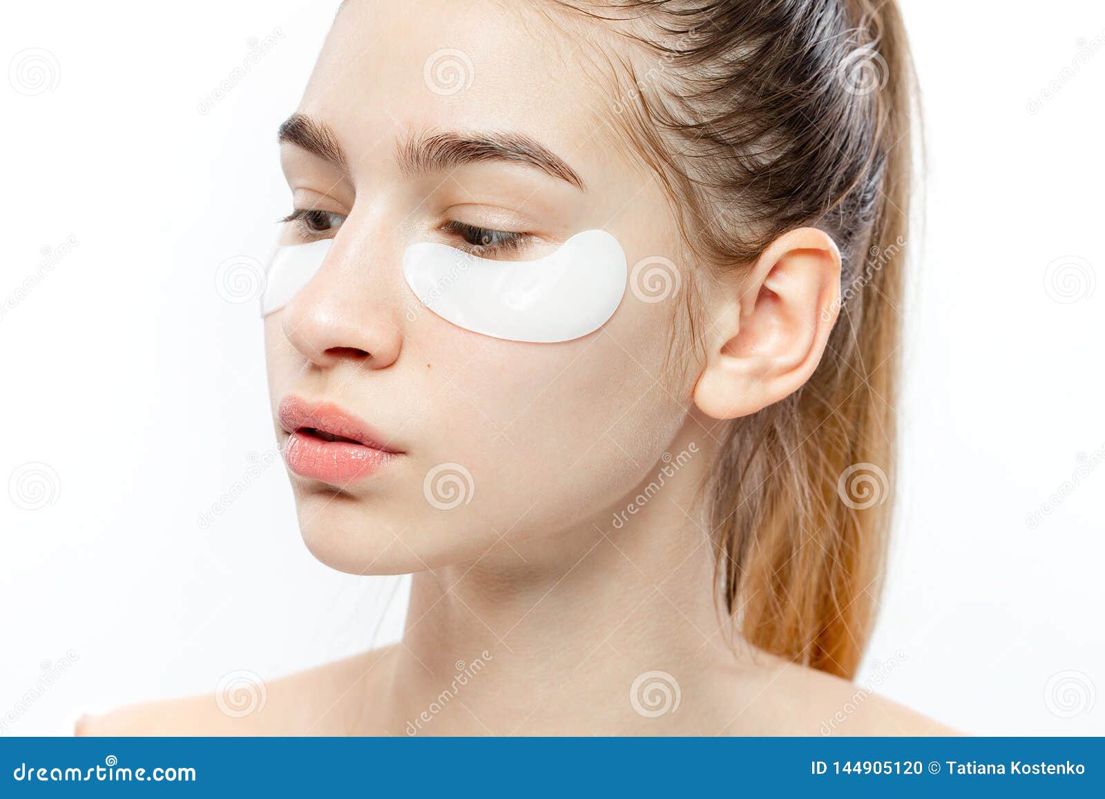 The Face of a Young Girl with Patches Under the Eyes Stock Photo ...