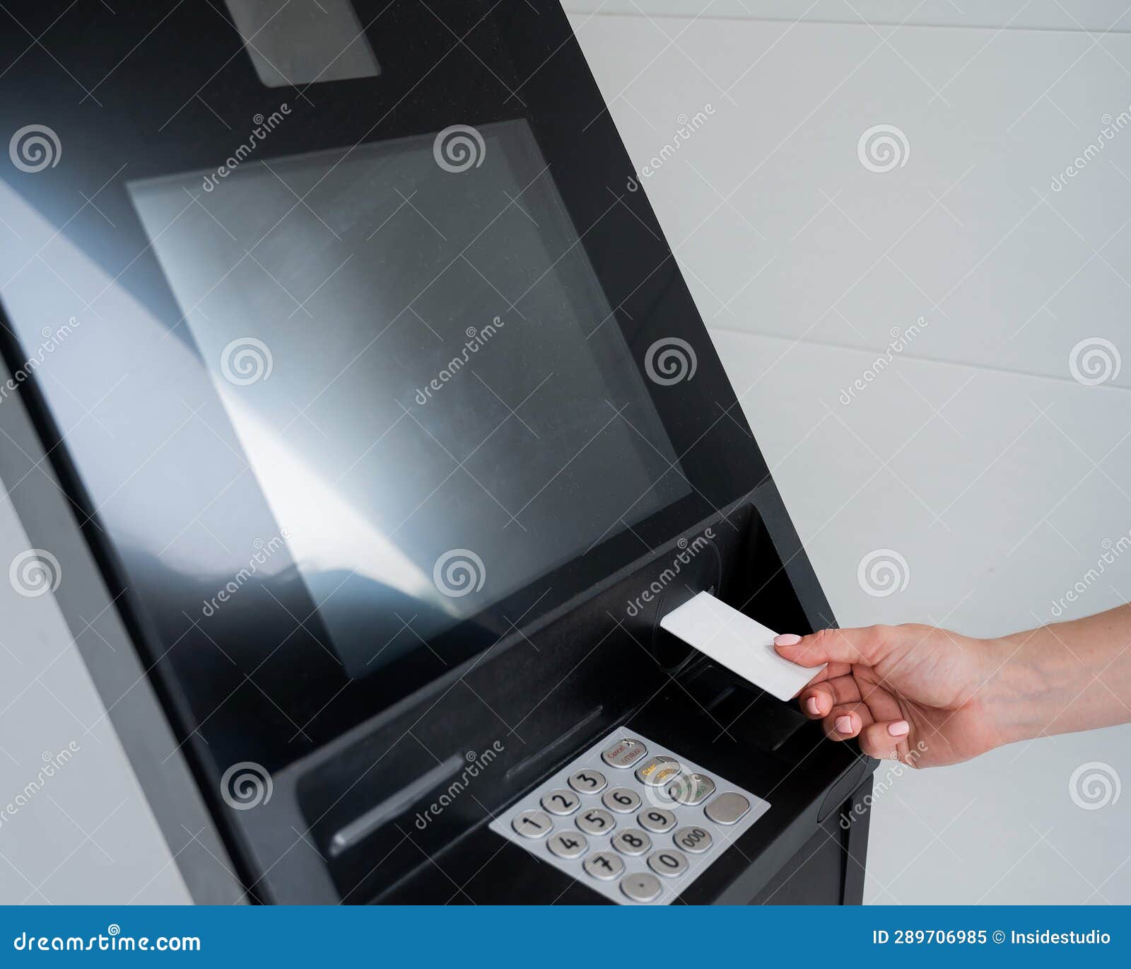 A Faceless Woman Inserts a Credit Card into an ATM. Close-up of a Woman ...