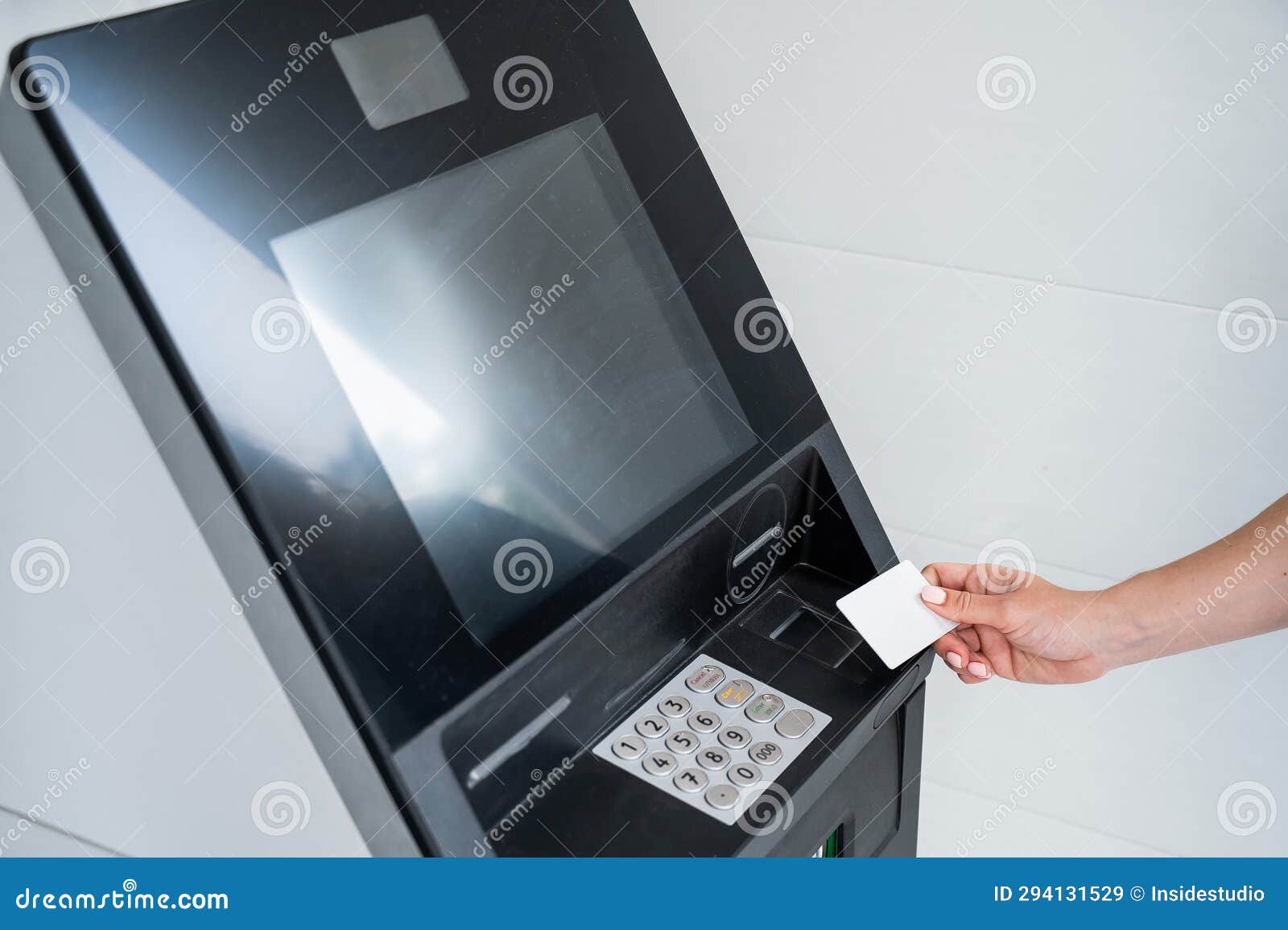 A Faceless Woman Inserts a Credit Card into an ATM. Close-up of a Woman ...