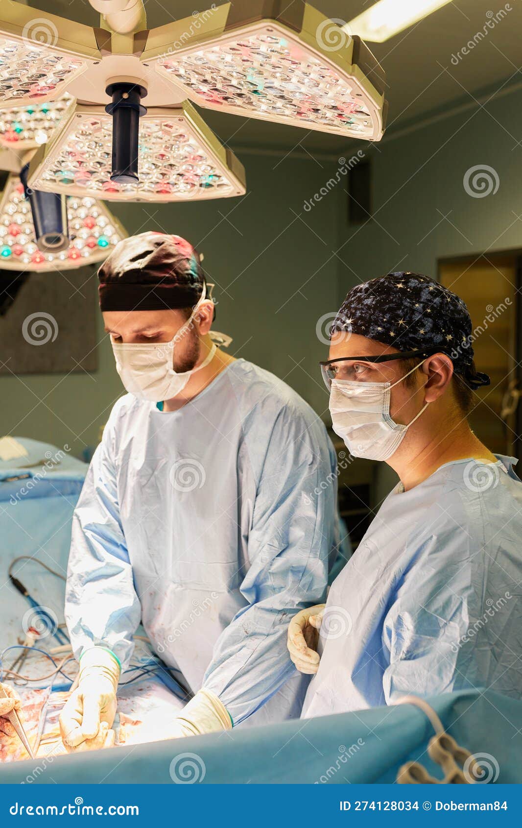Faces of Surgeons in the Operating Room during the Operation. Modern ...